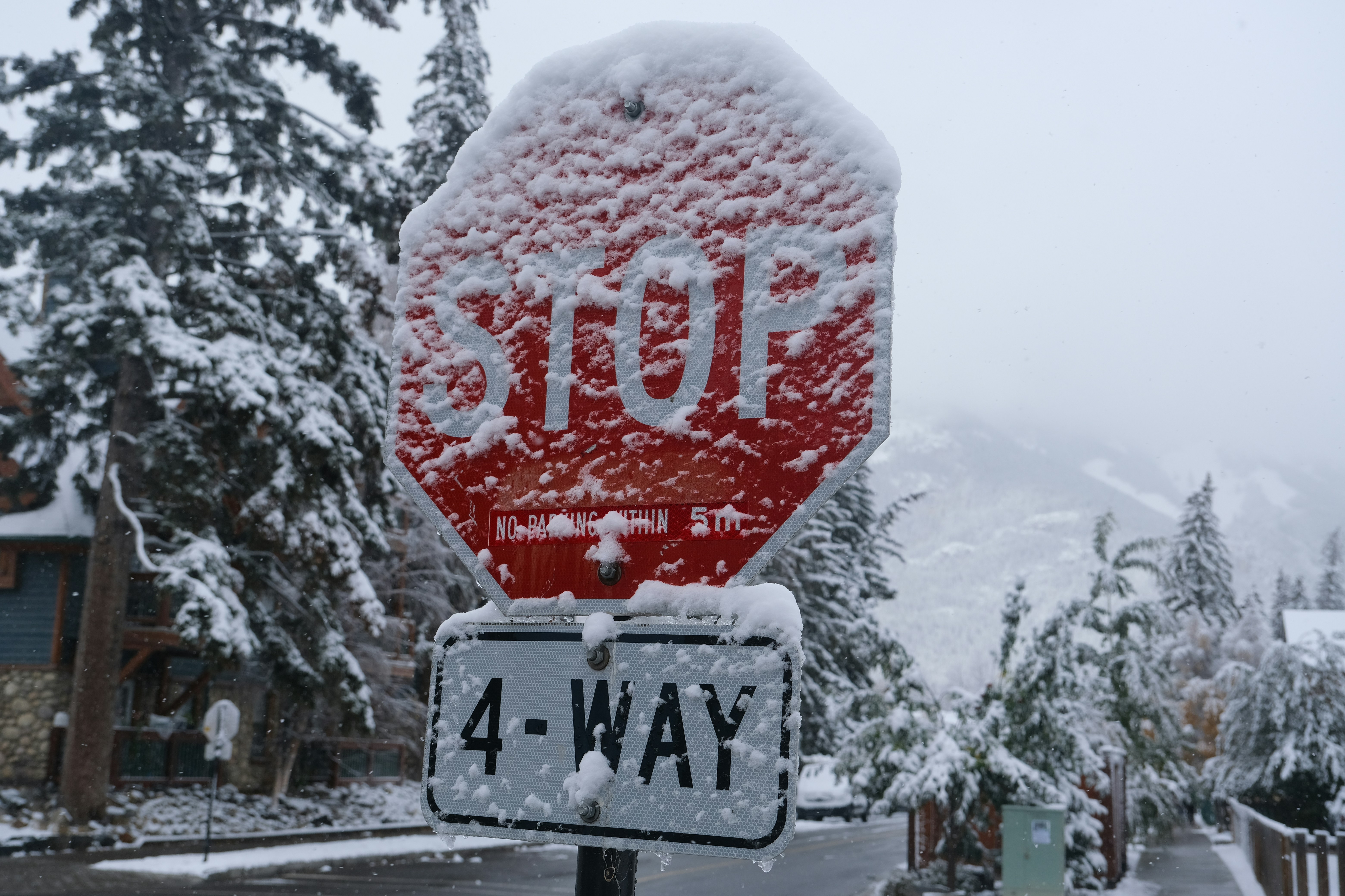 Crimson Stop Sign Stands Against a Snowbound Mountain Town