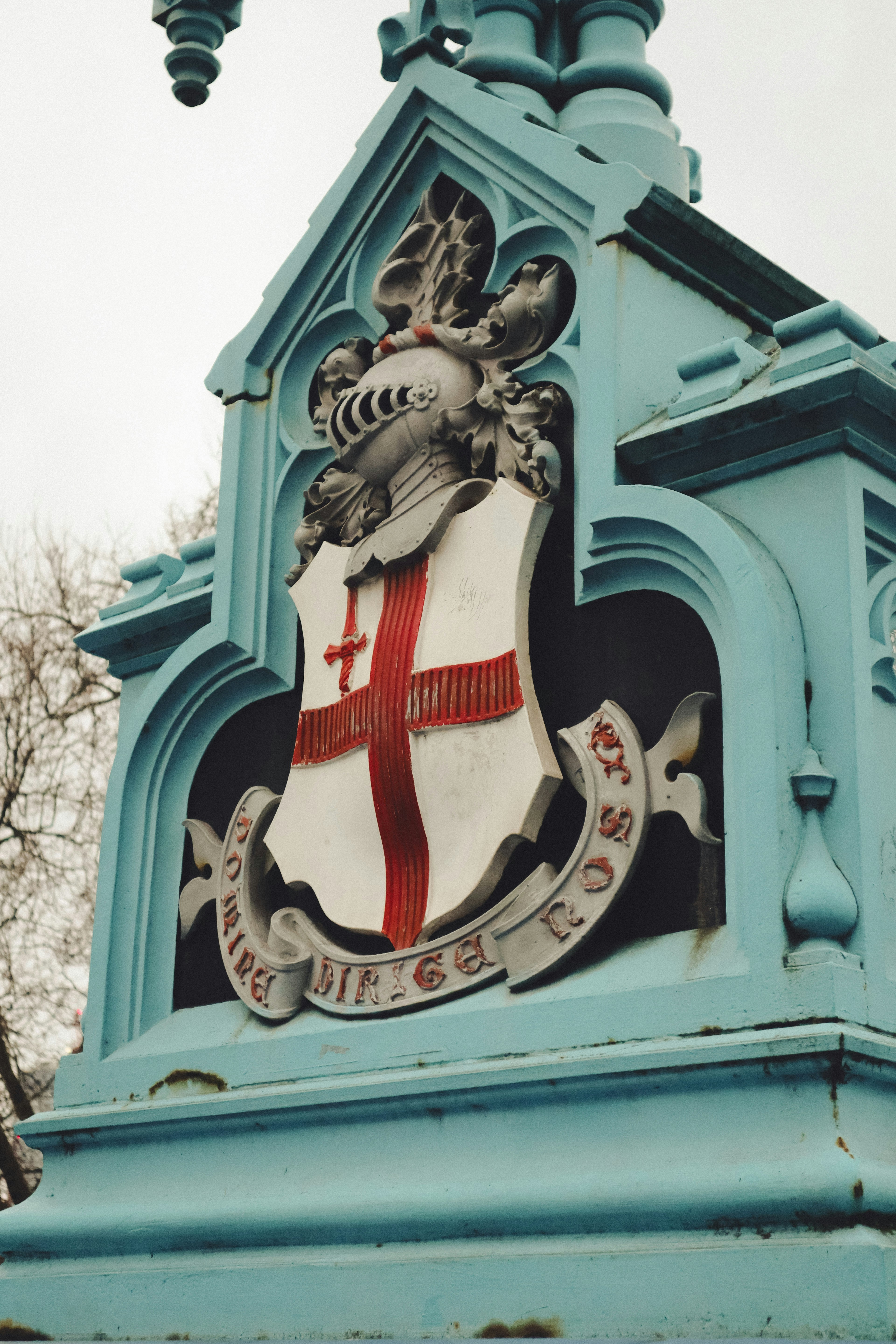 Azure Crest in Stone: a turquoise monument bearing a crimson-cross shield