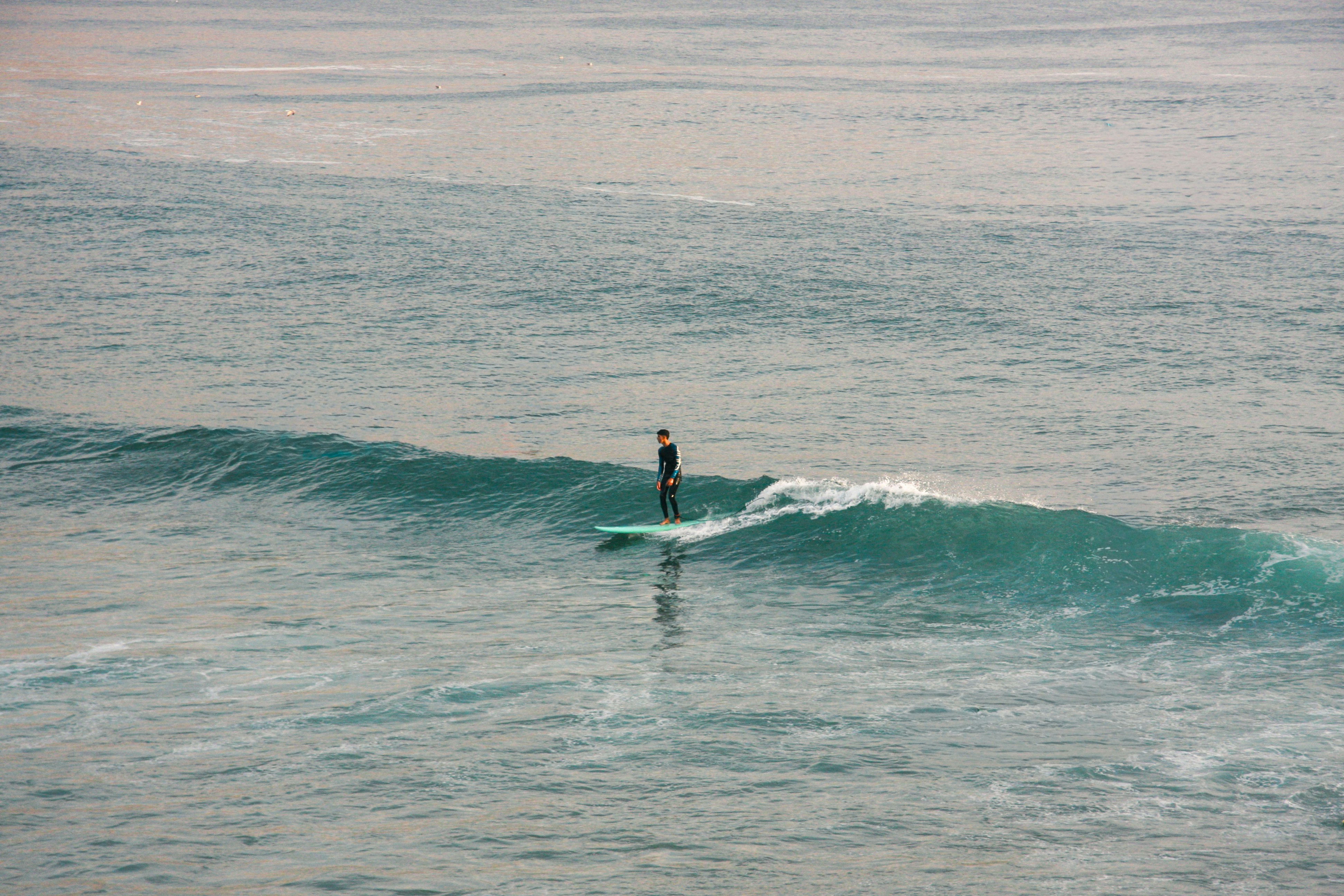 Surfer riding a wave in Imsouane, Morocco