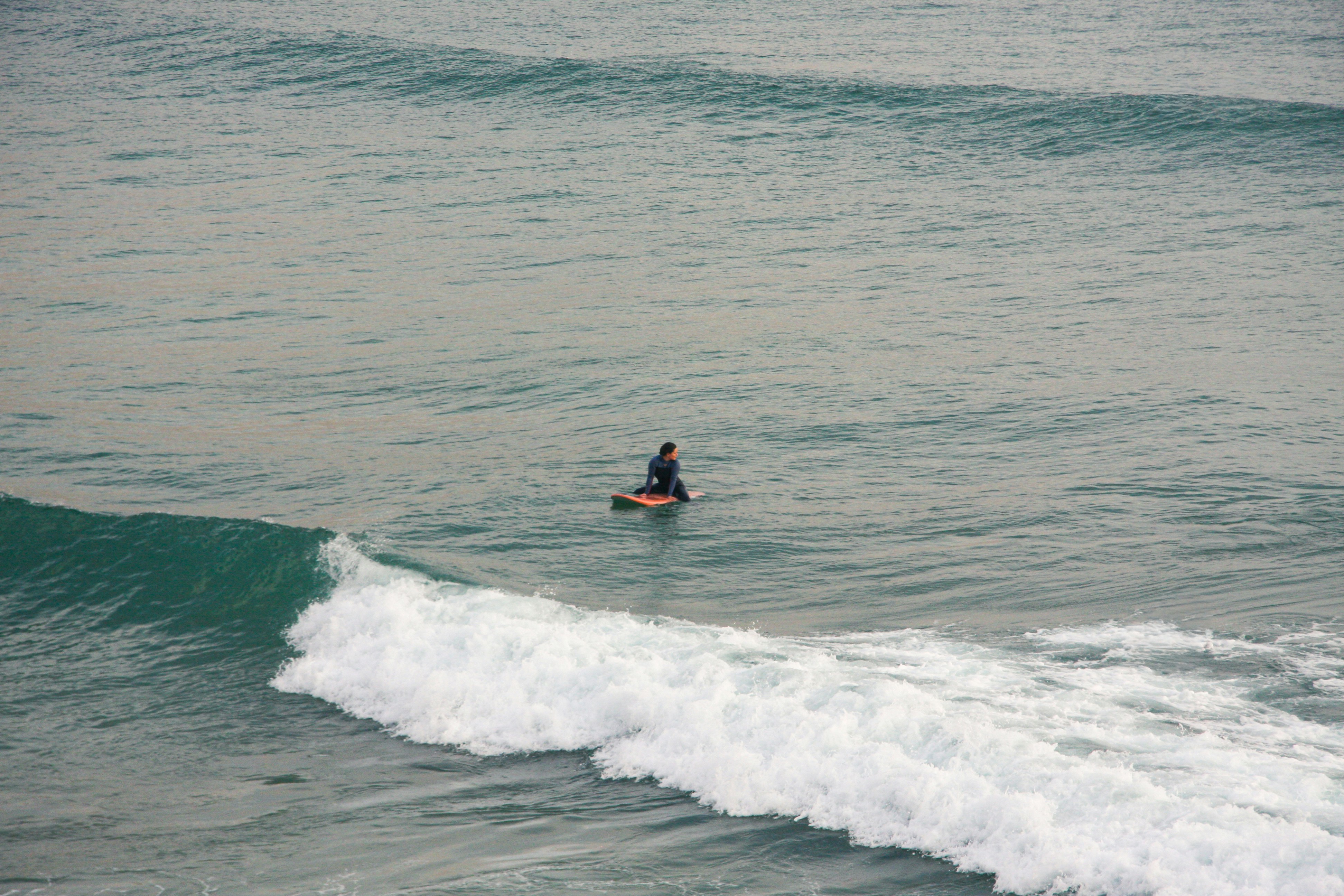 Surfer girl waiting for a wave in Imsouane, Morocco