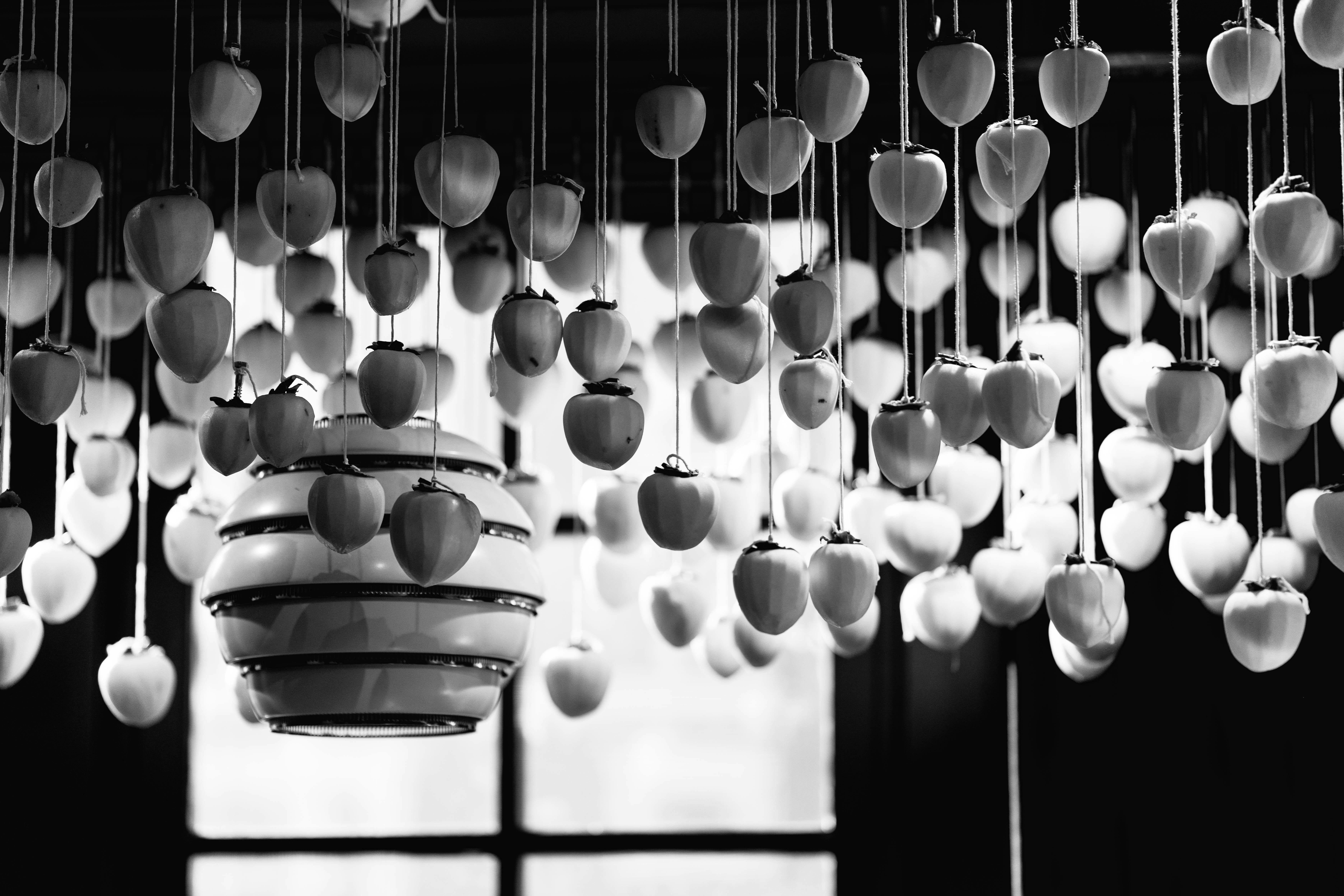 Monochrome Orbits: Spiral Lantern Amid Hanging Hearts