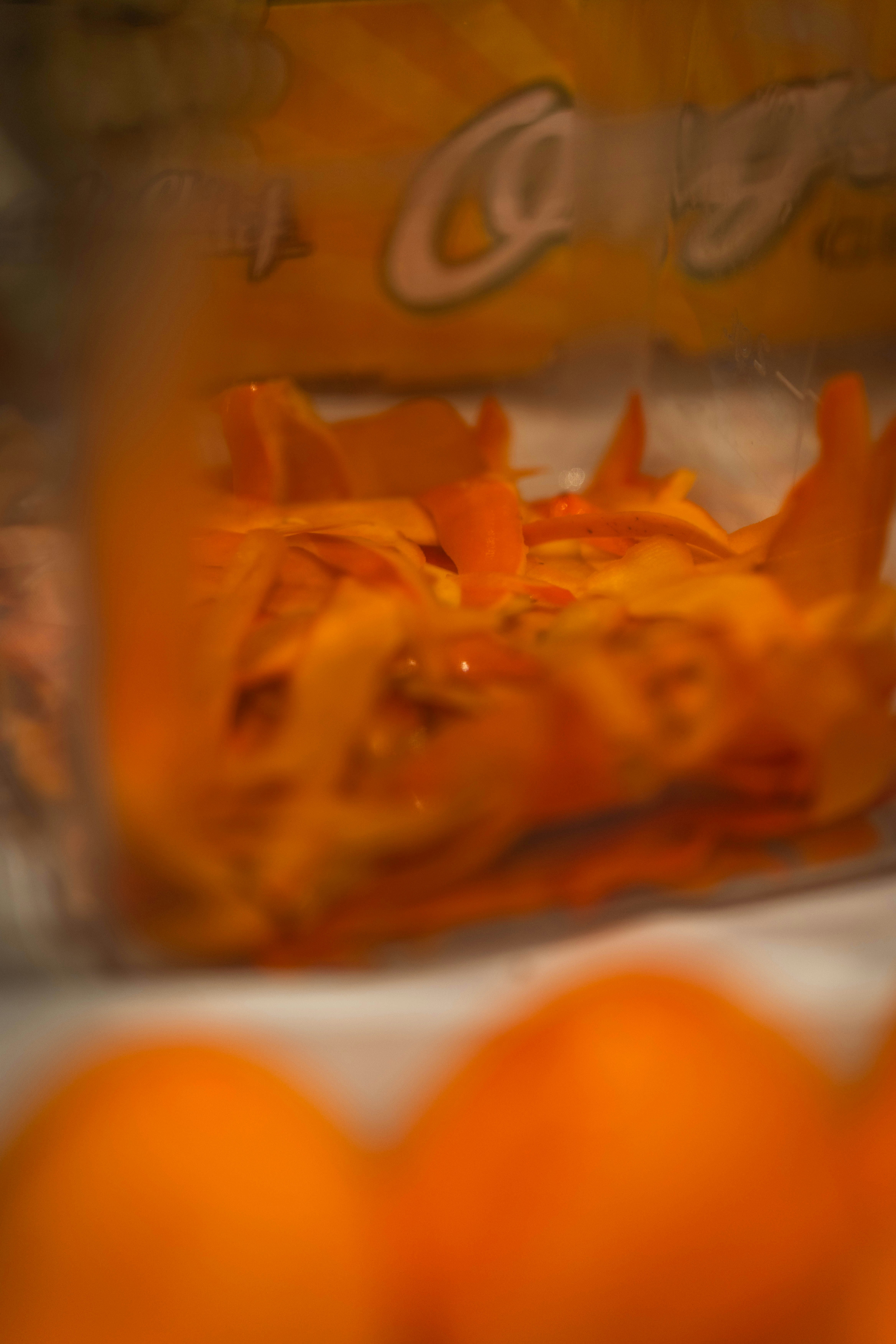 Amber Citrus Shreds in a Glass Vessel: A Soft-Focus Close-Up