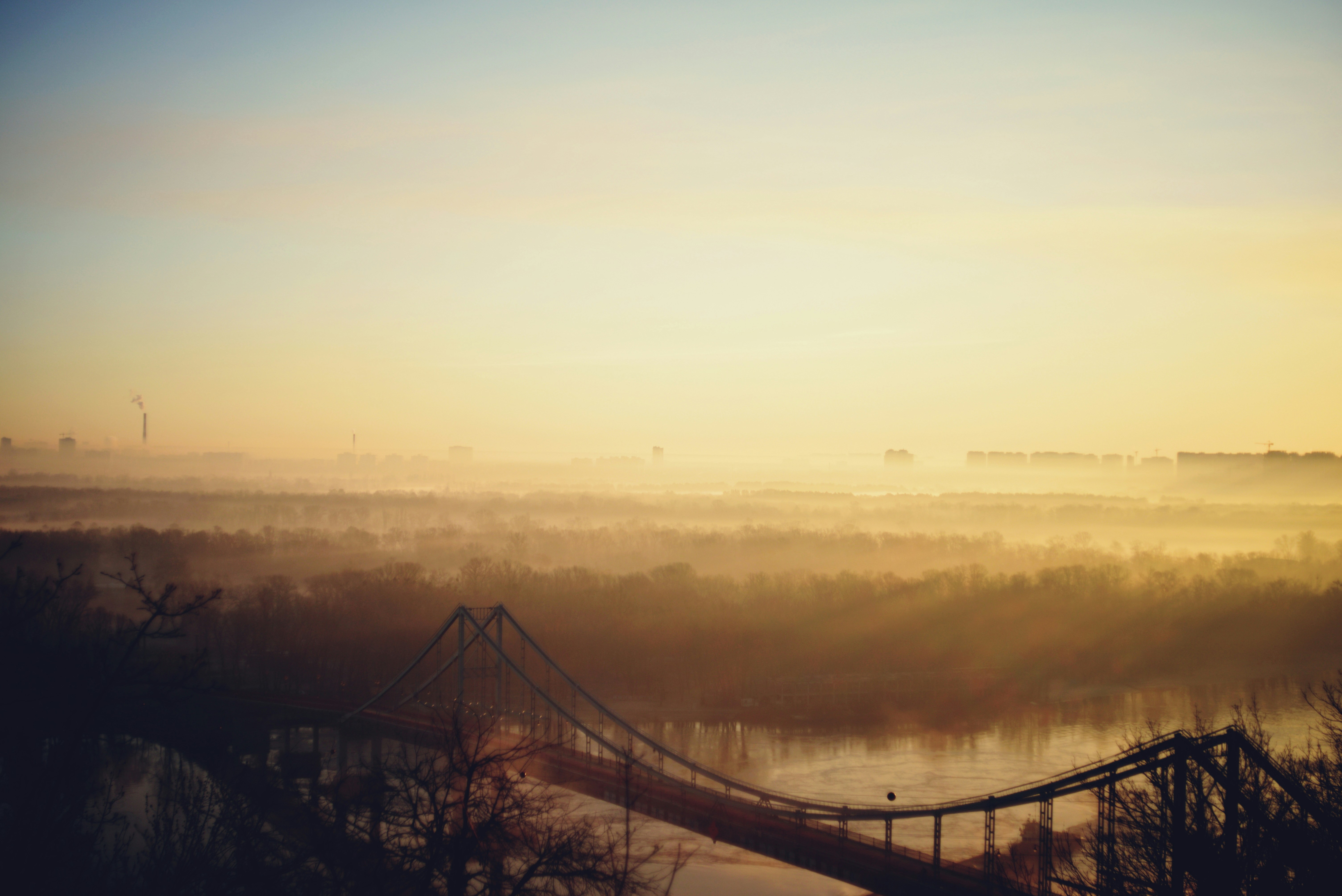 Dawn Veil Over the Riverside Suspension Bridge