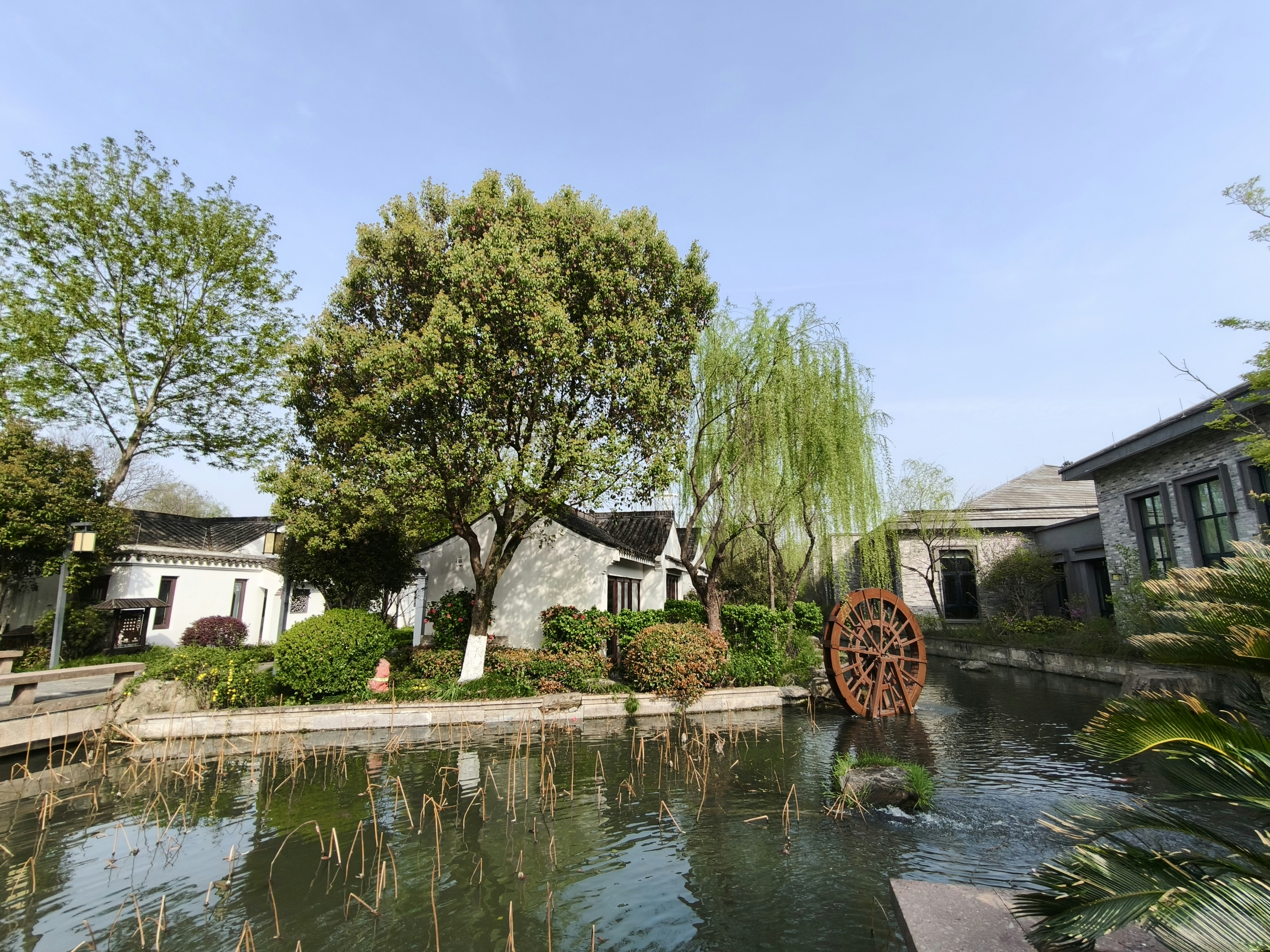 Traditional village with a pond and water wheel