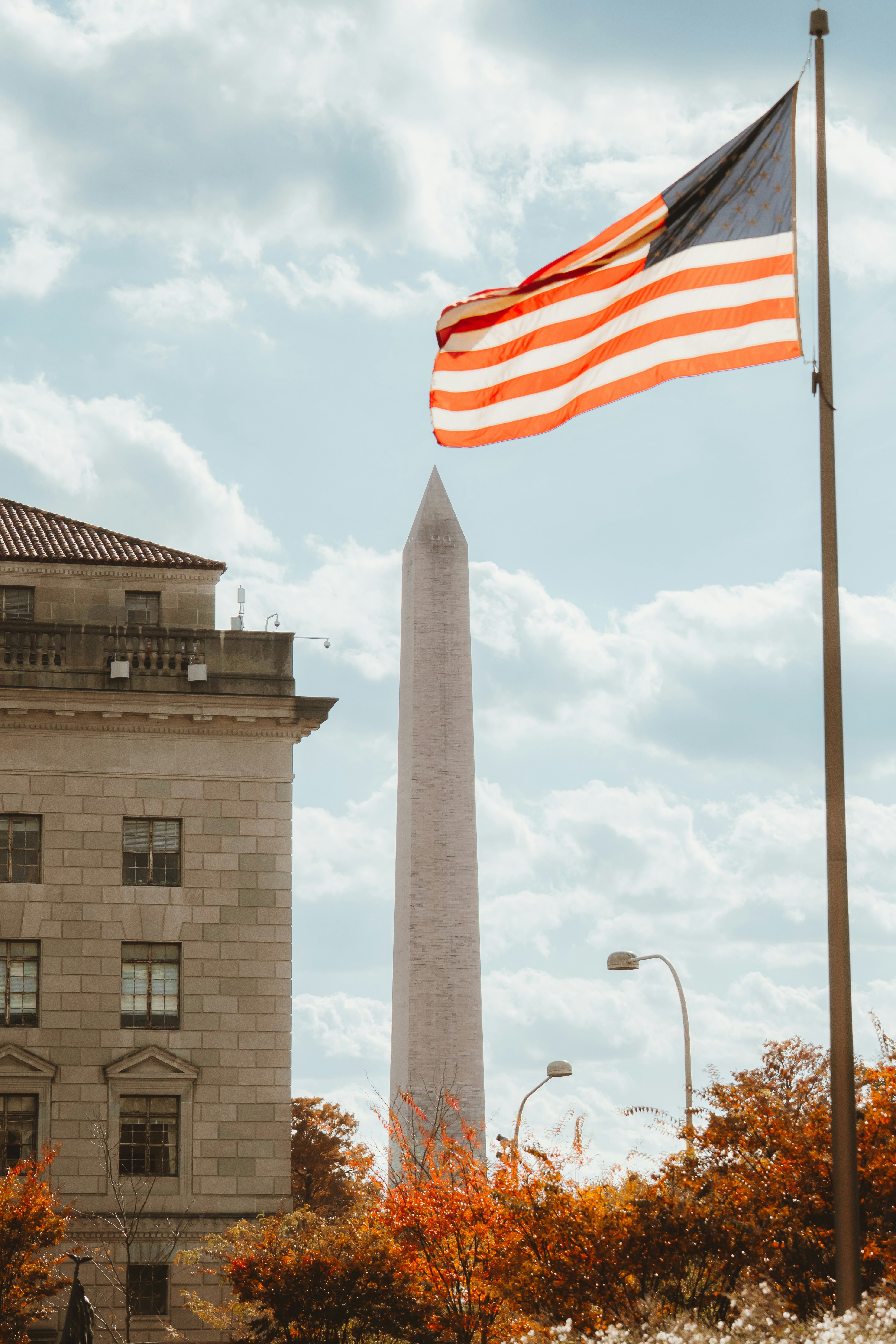 Flag Above the Washington Monument: Autumn Light over DC Street Scene
