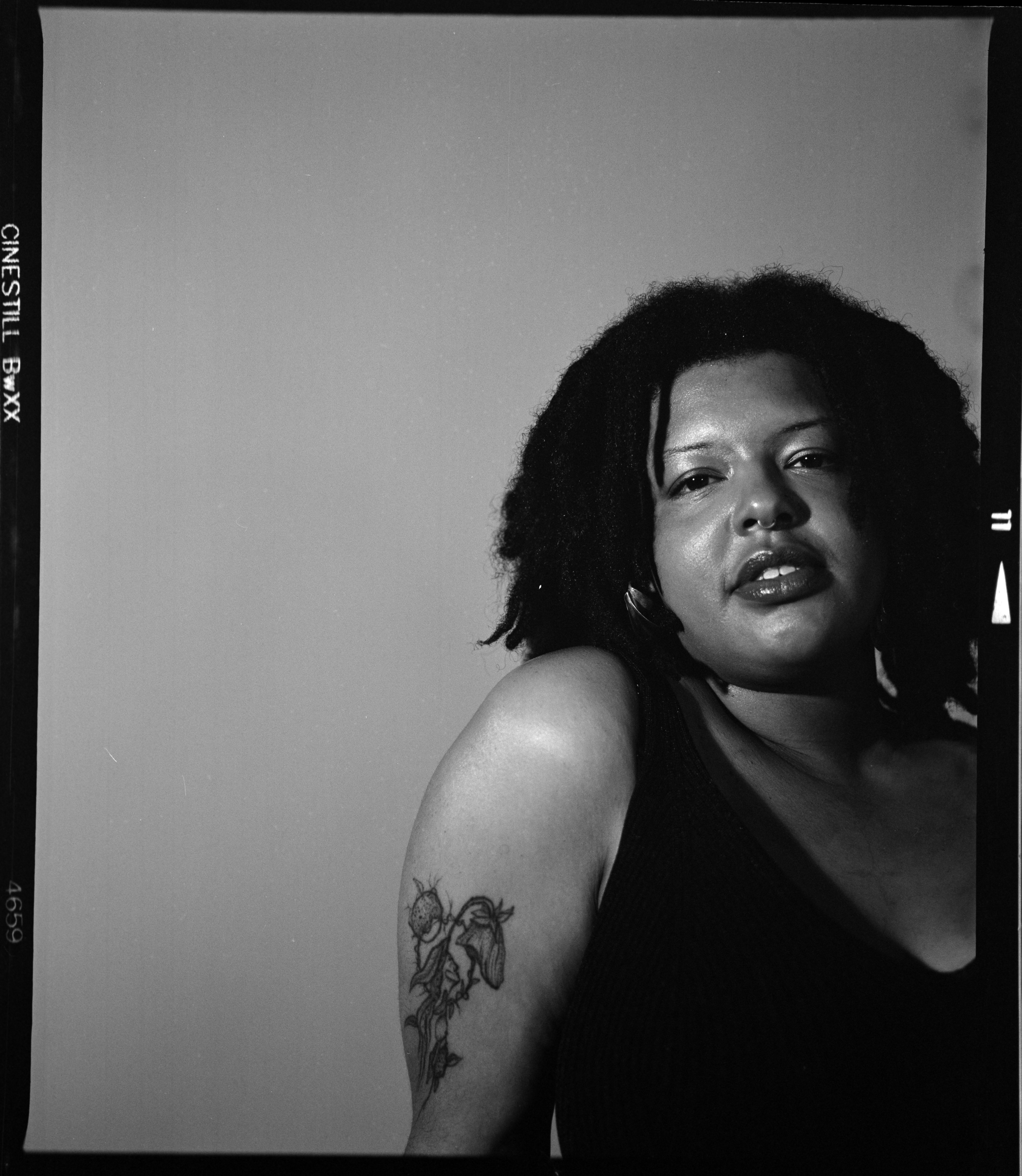 Noir Intimacy: A Black-and-White Portrait with Inked Arm