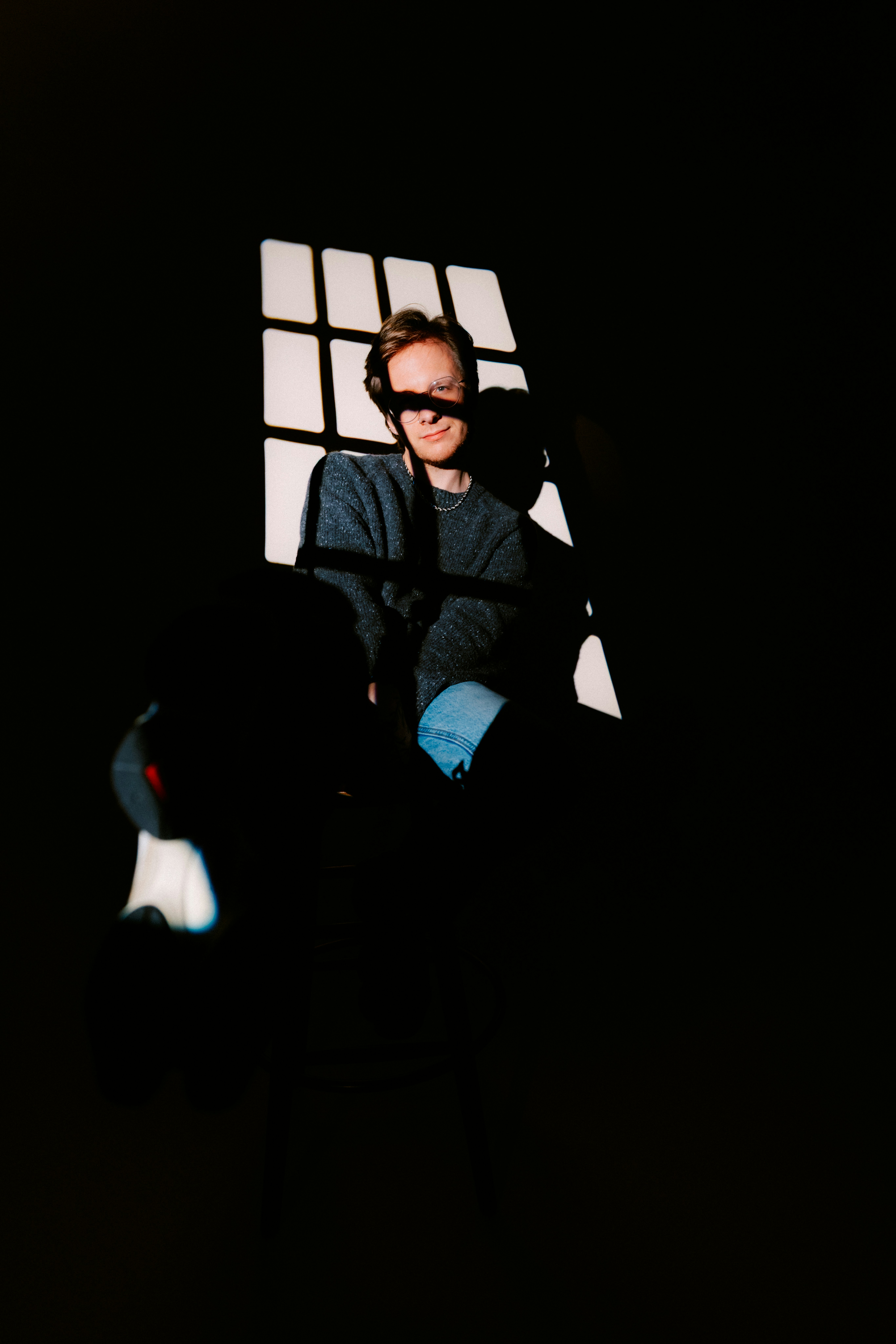 Gridlight Portrait: A Quiet Face Emerges from Shadow