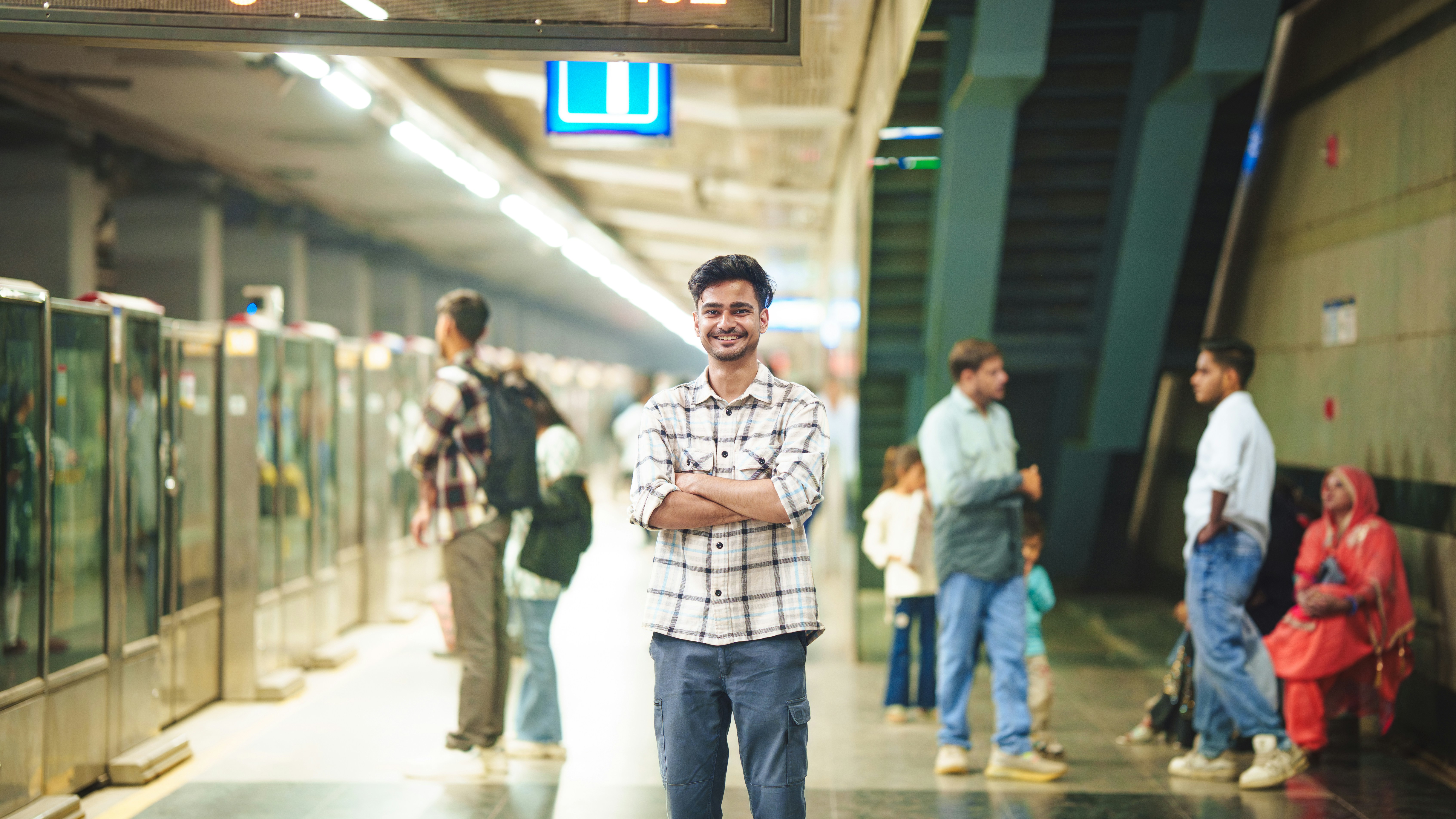 Portrait of an Indian man at a metro station and inside the metro train. Represents daily urban commute, modern public transport, and contemporary city lifestyle in India.