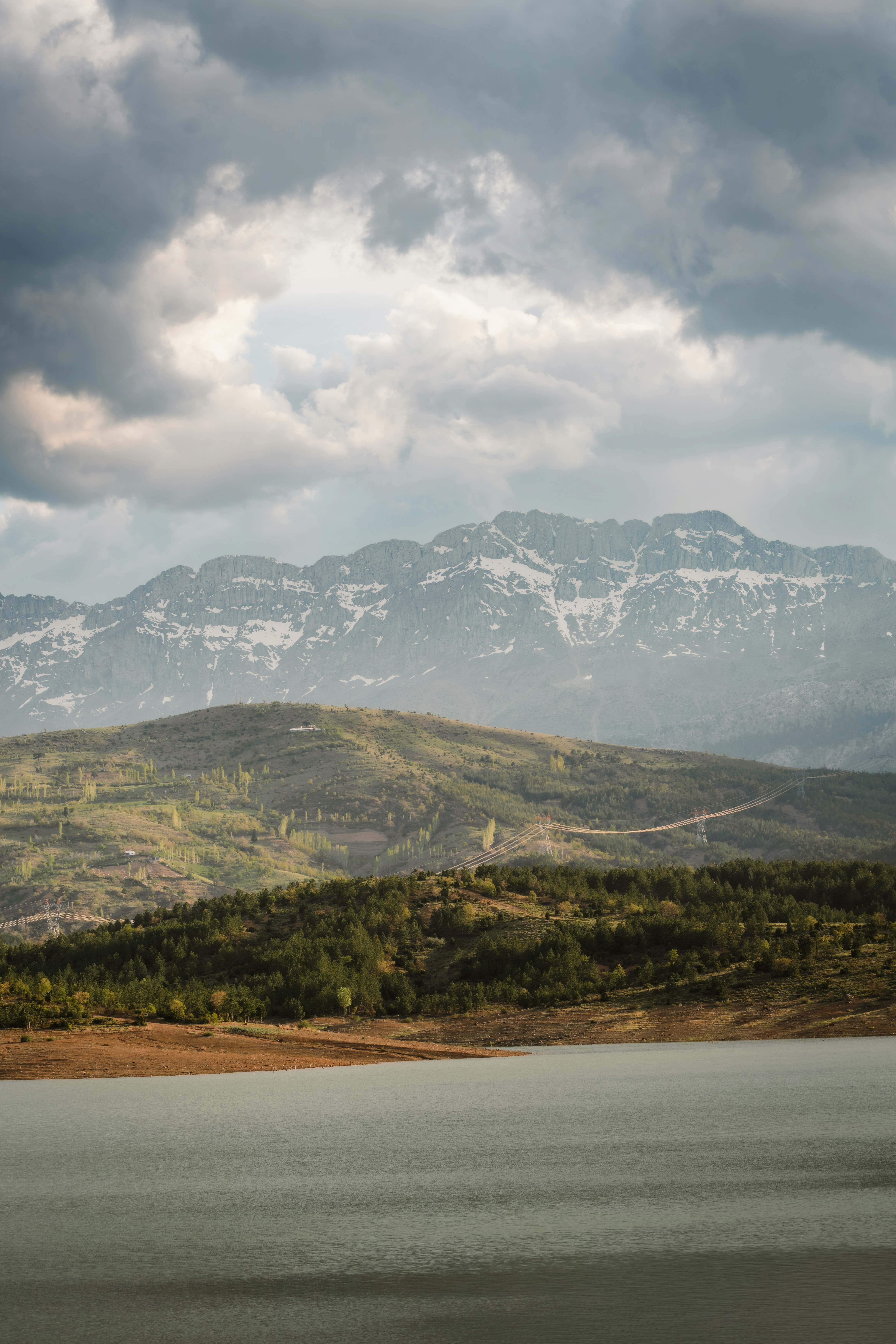 Snow-Capped Ridge Framed by a Quiet Lake