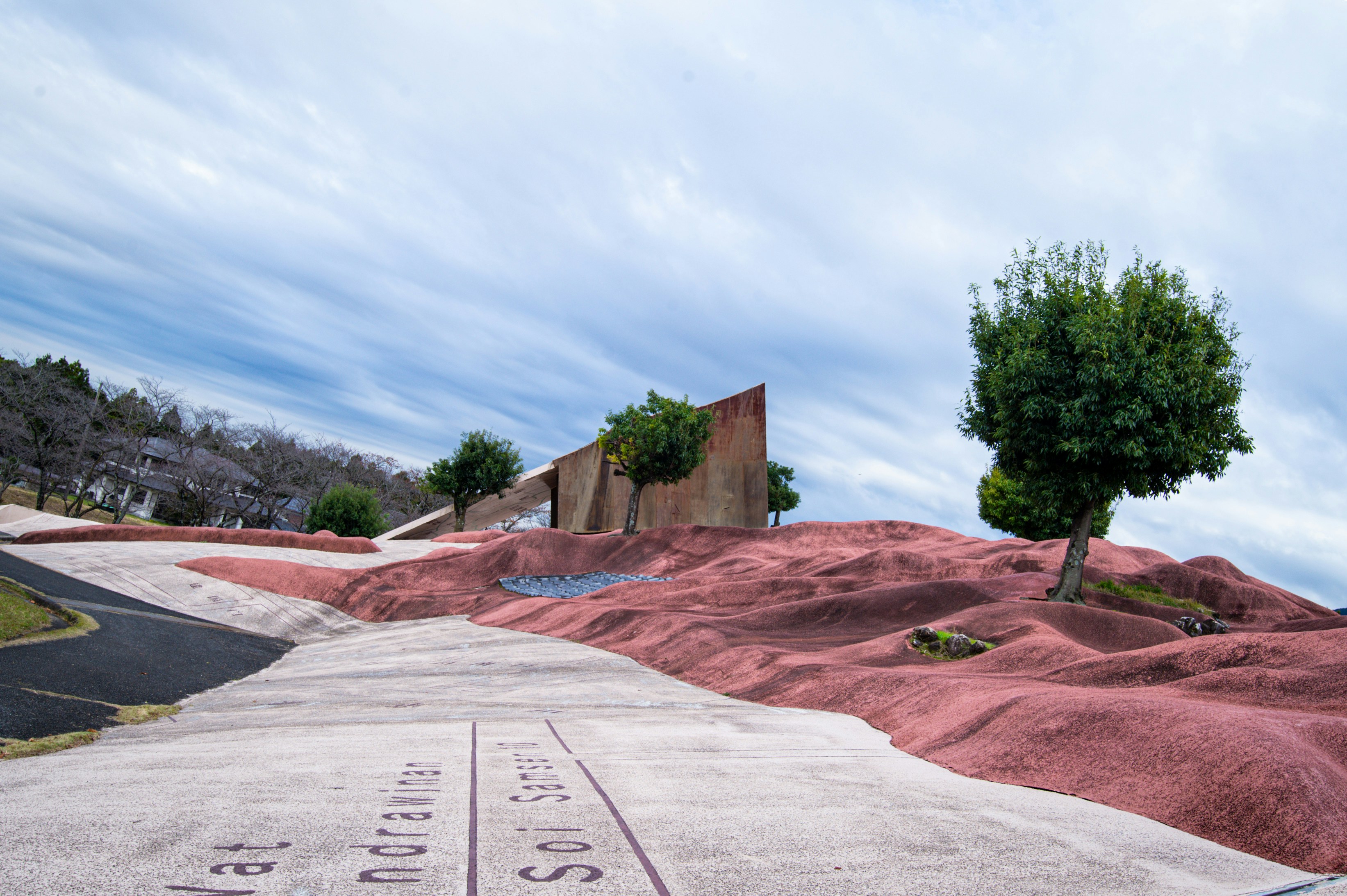 Converging Red Mounds and a Serpentine Promenade