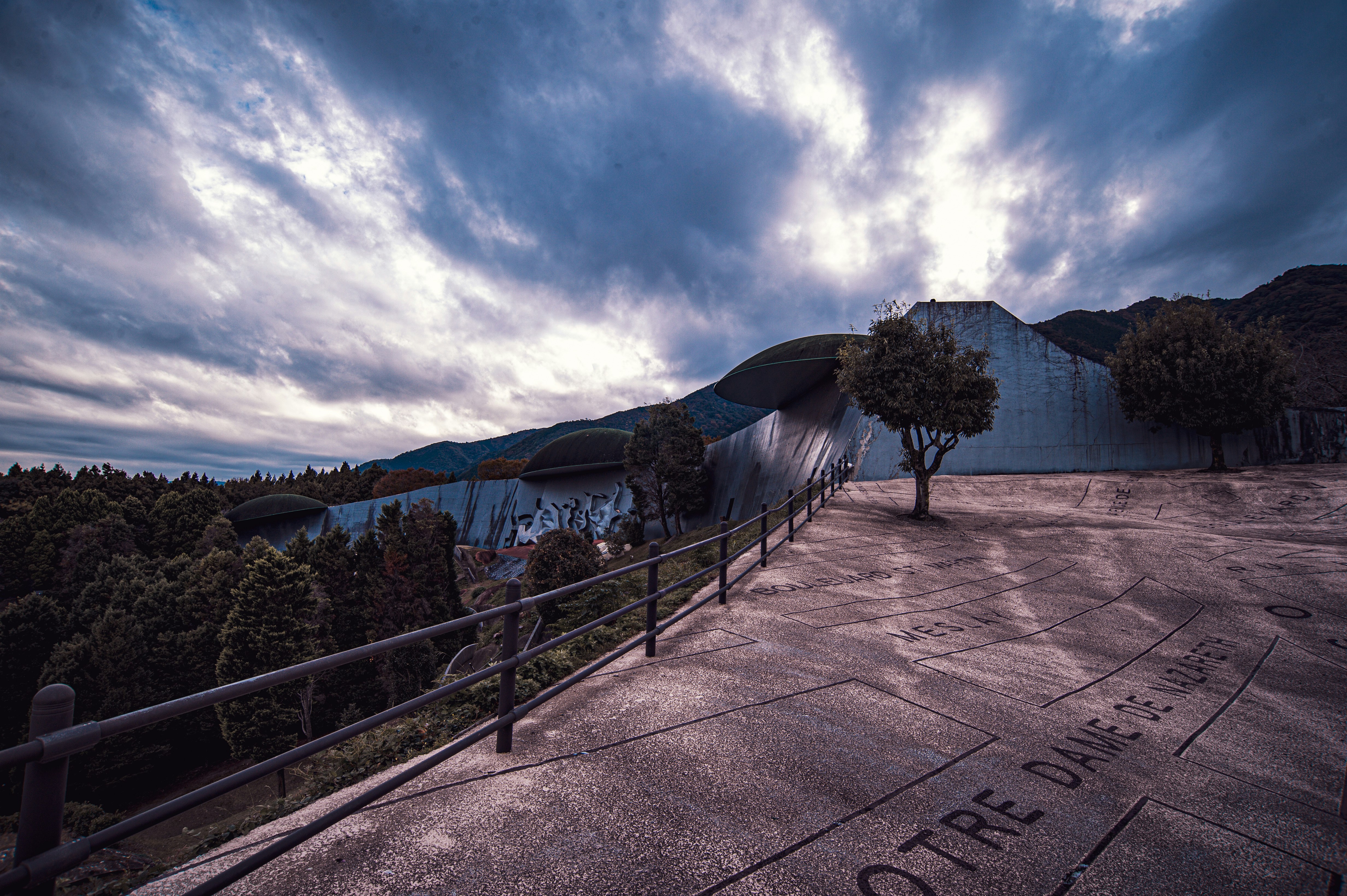 Overlook on the Concrete Ridge Beneath a Storm-Lit Horizon