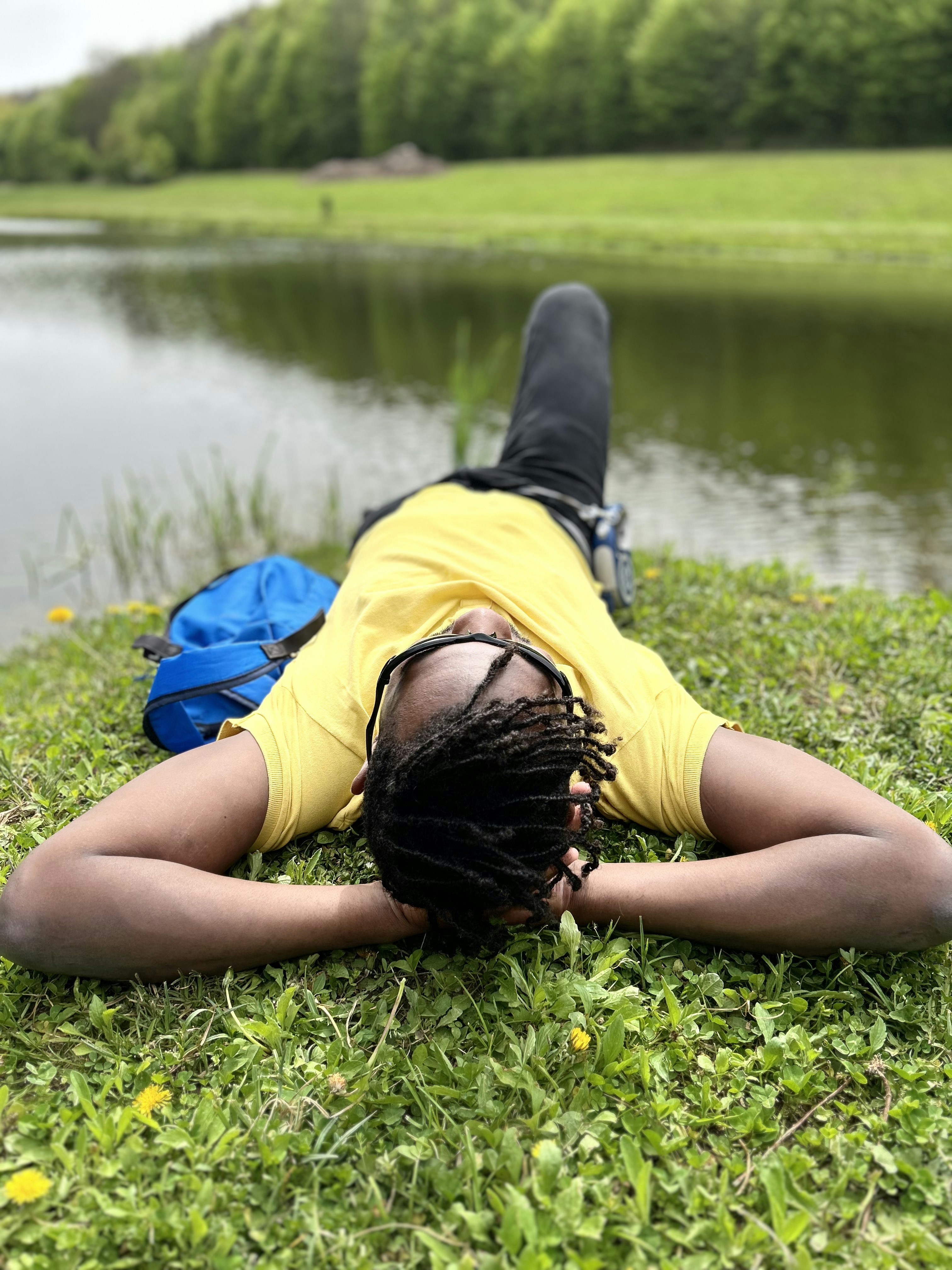 Yellow Calm by the Lake: A Reclined Moment on Verdant Banks