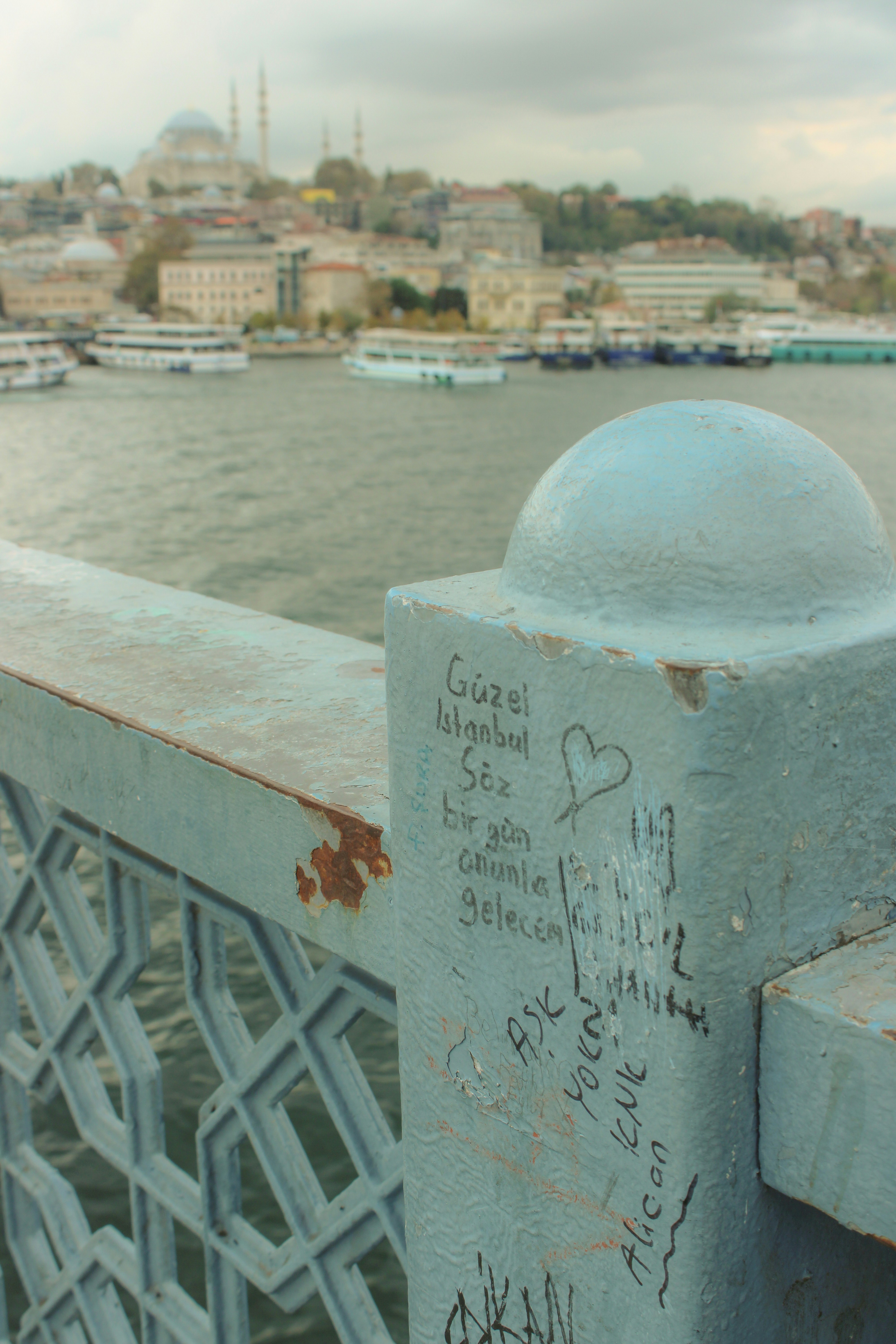 Blue Bollard on Galata Bridge: Graffiti, Sea Light, and Istanbul's Waterfront Skyline