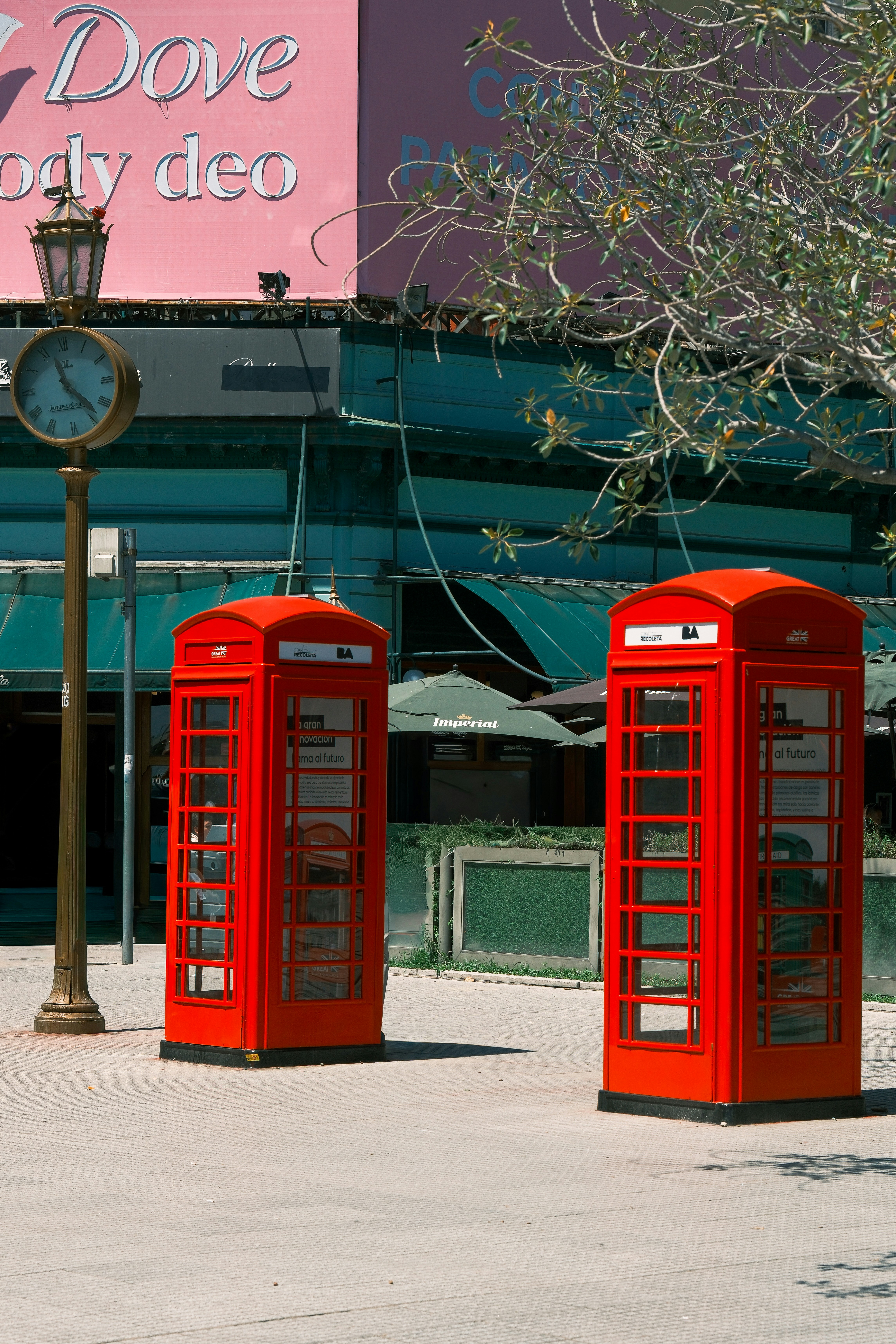 Crimson Kiosks Stand Bold in a Sunlit Urban Plaza