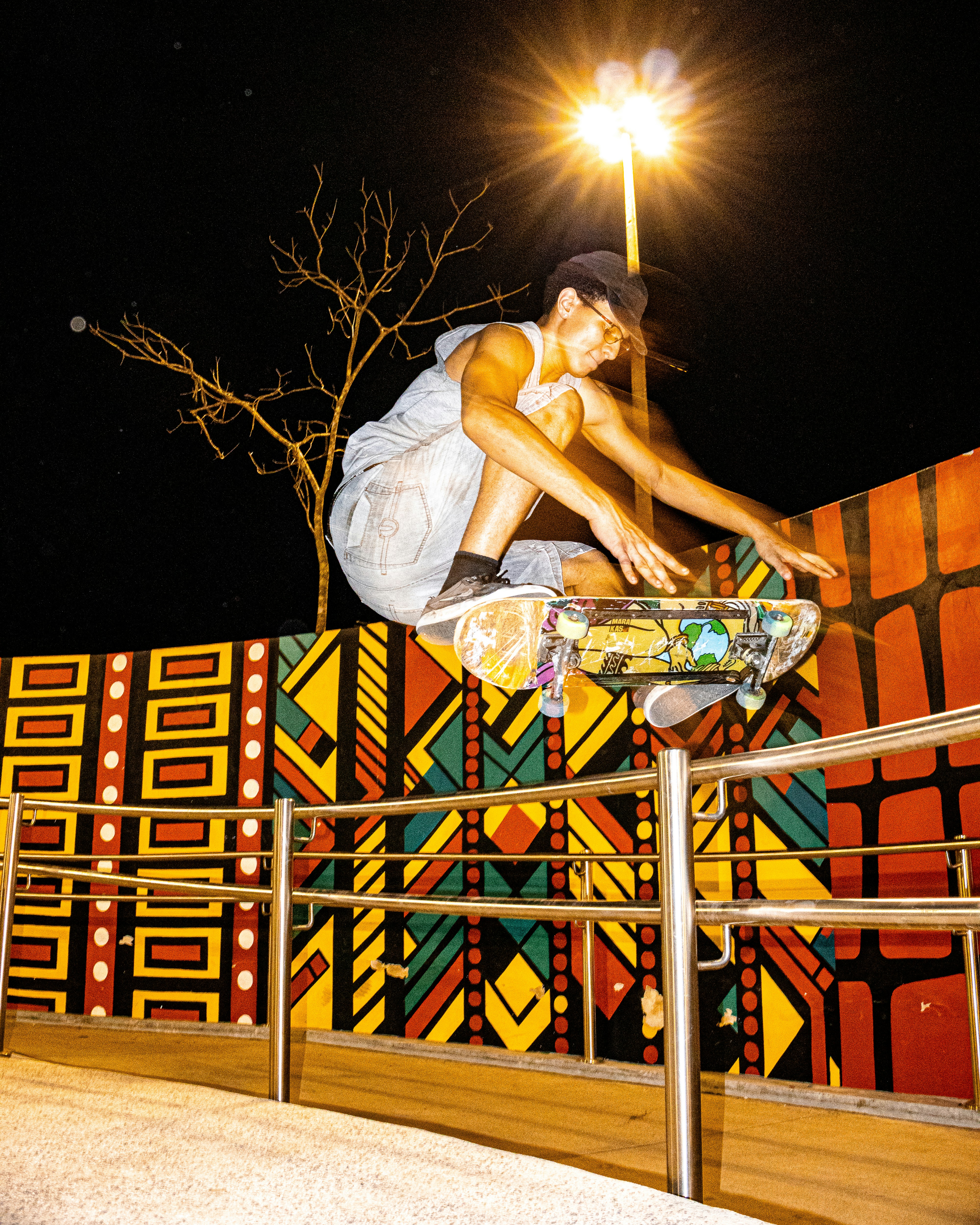 Mid-Air Flip Over a Colorful Geometric Wall at Night