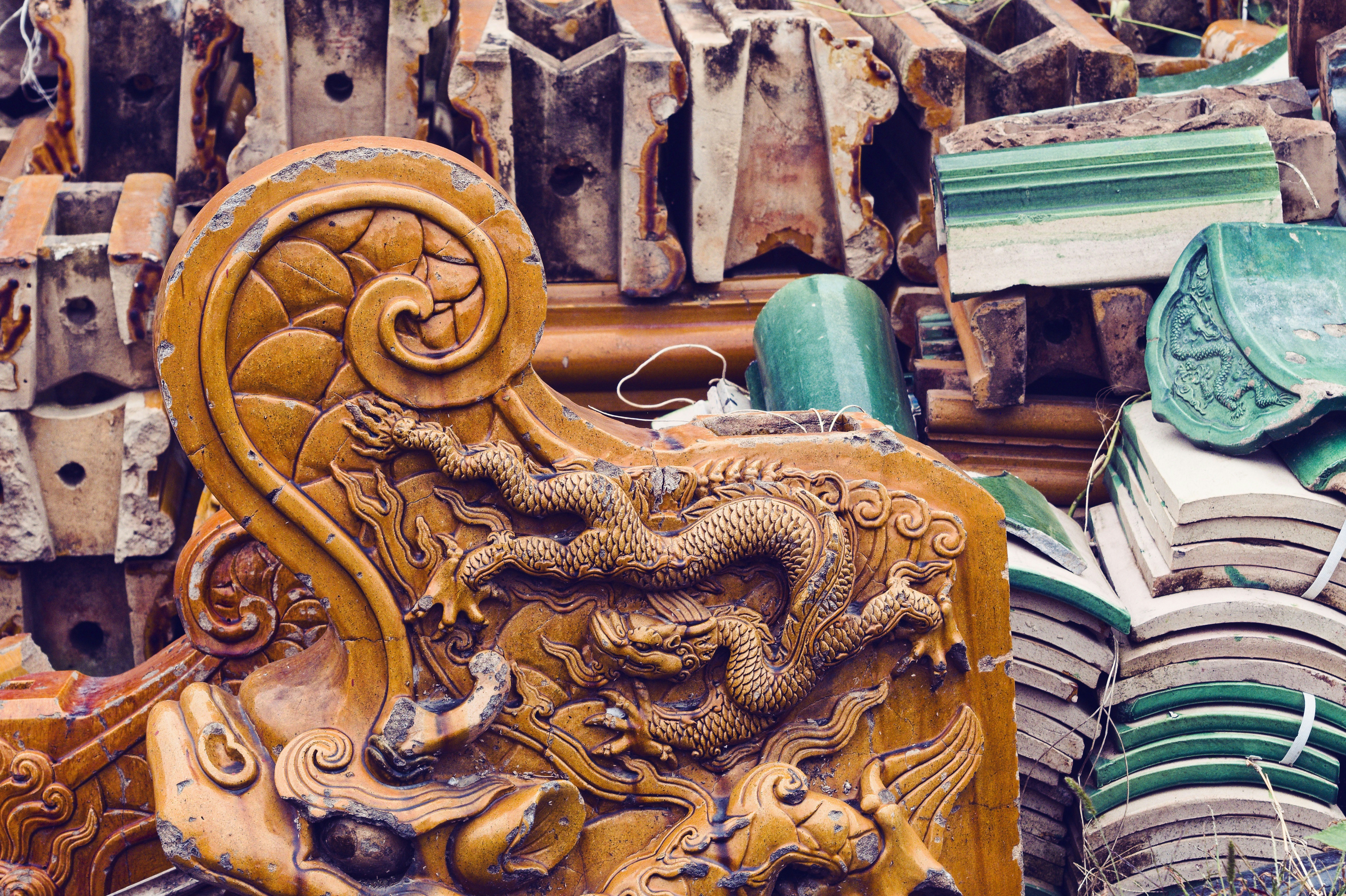 Amber Dragon Relic Among Stacked Roof Tiles