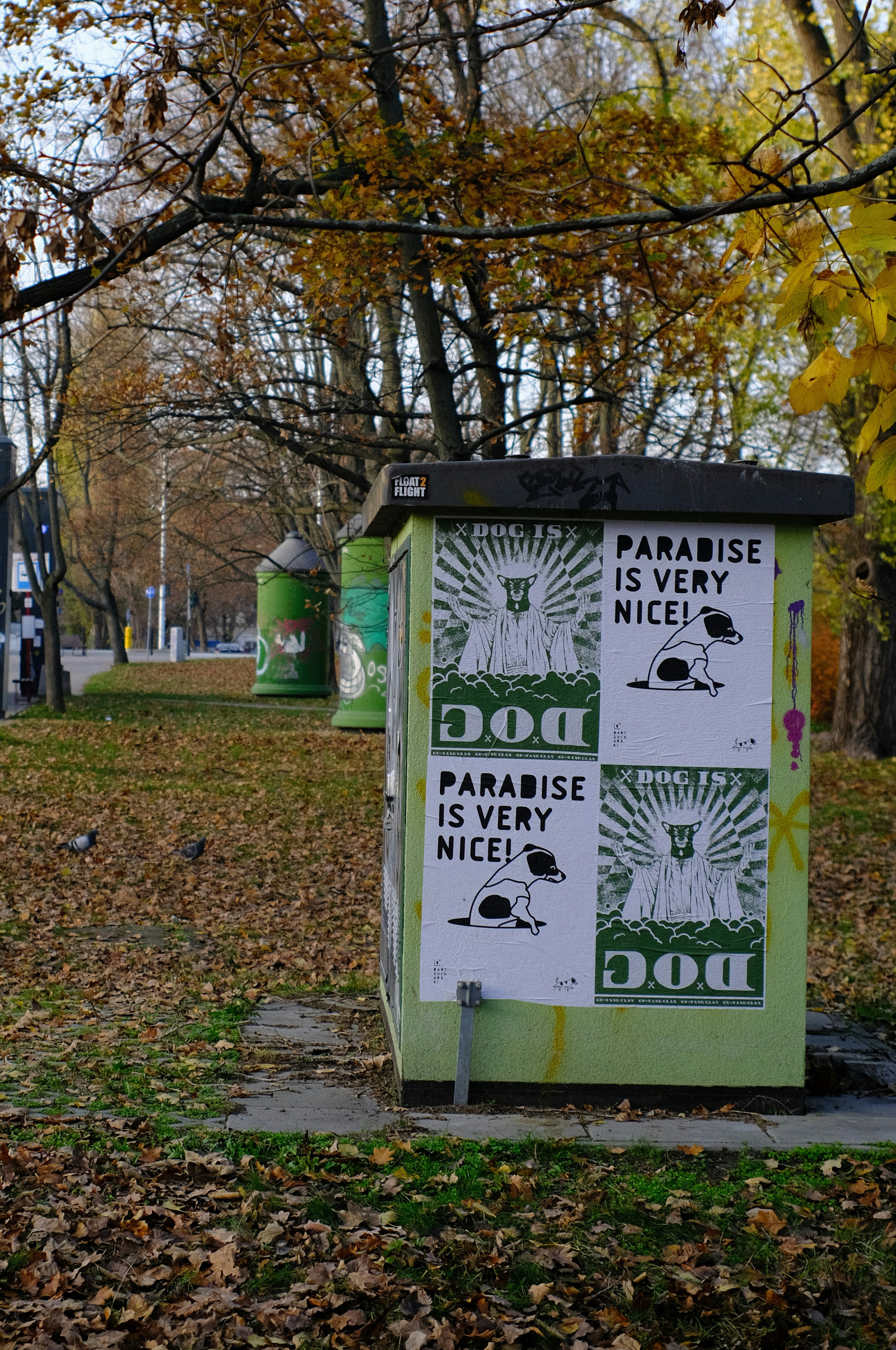 Paradise Posters on a Green Park Box Amid Autumn Leaves
