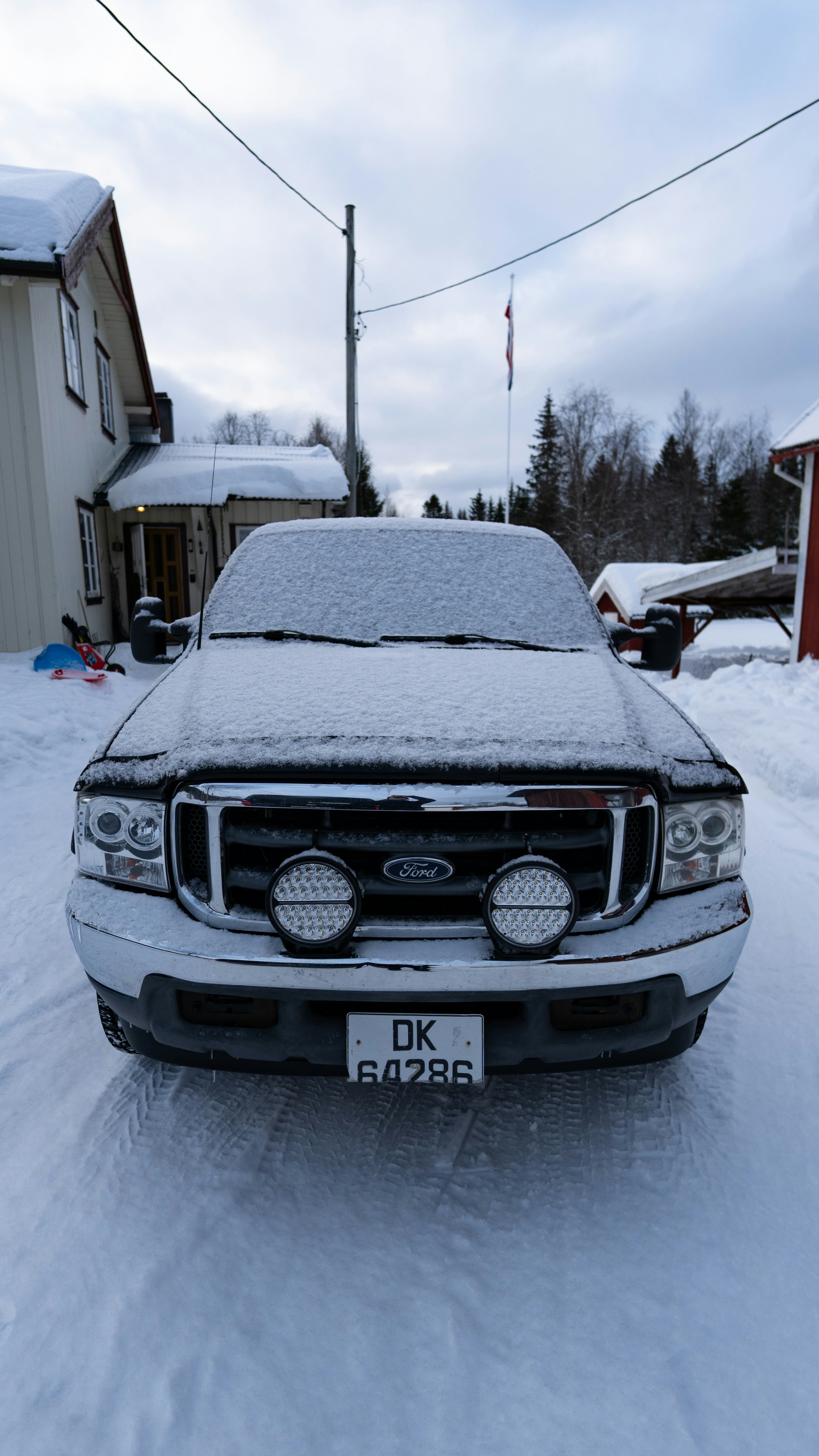 Snowbound Ford Front View in a Quiet Suburban Driveway