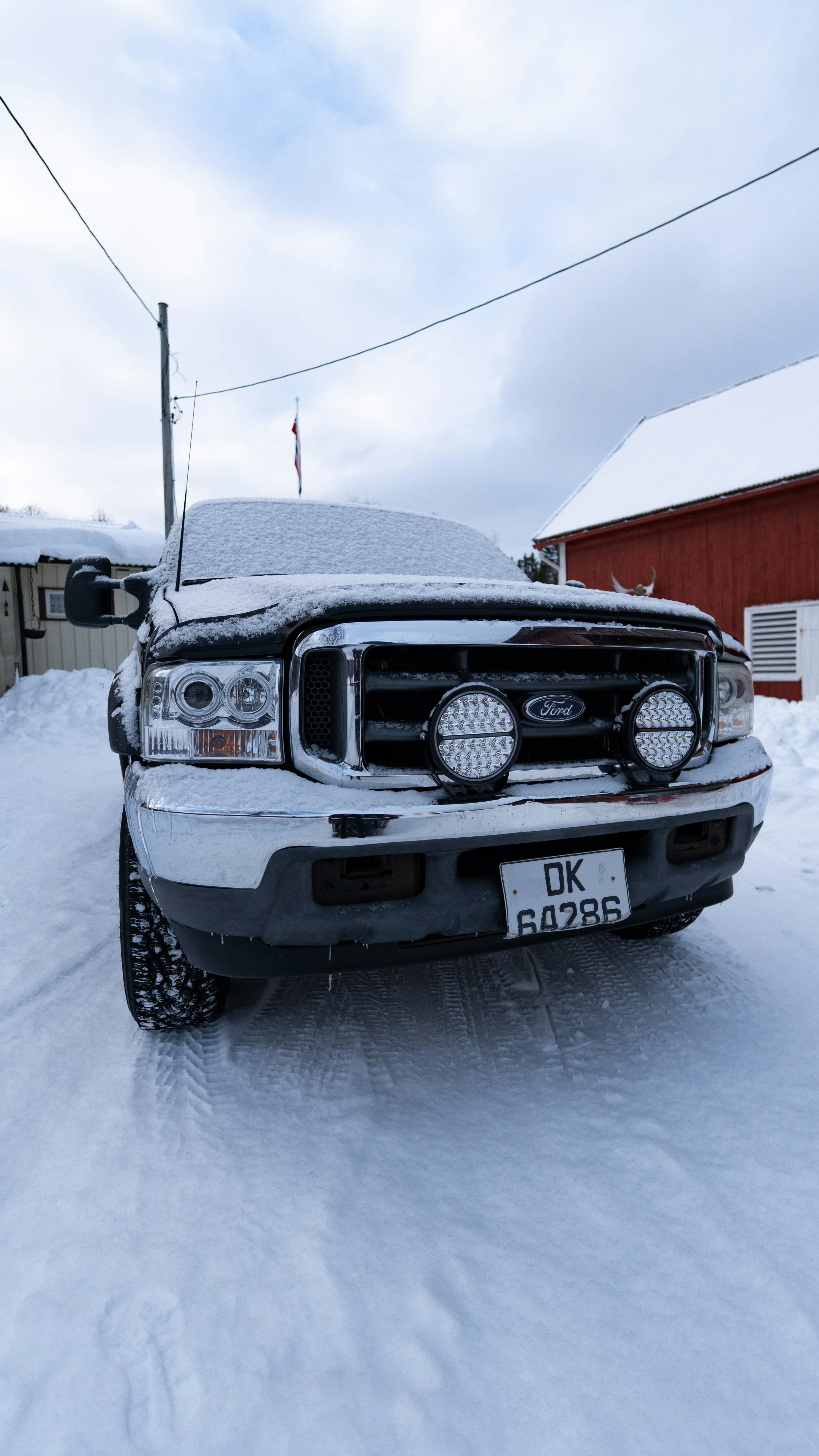 Snowbound Ford Front: Chrome Grille Under Winter Light