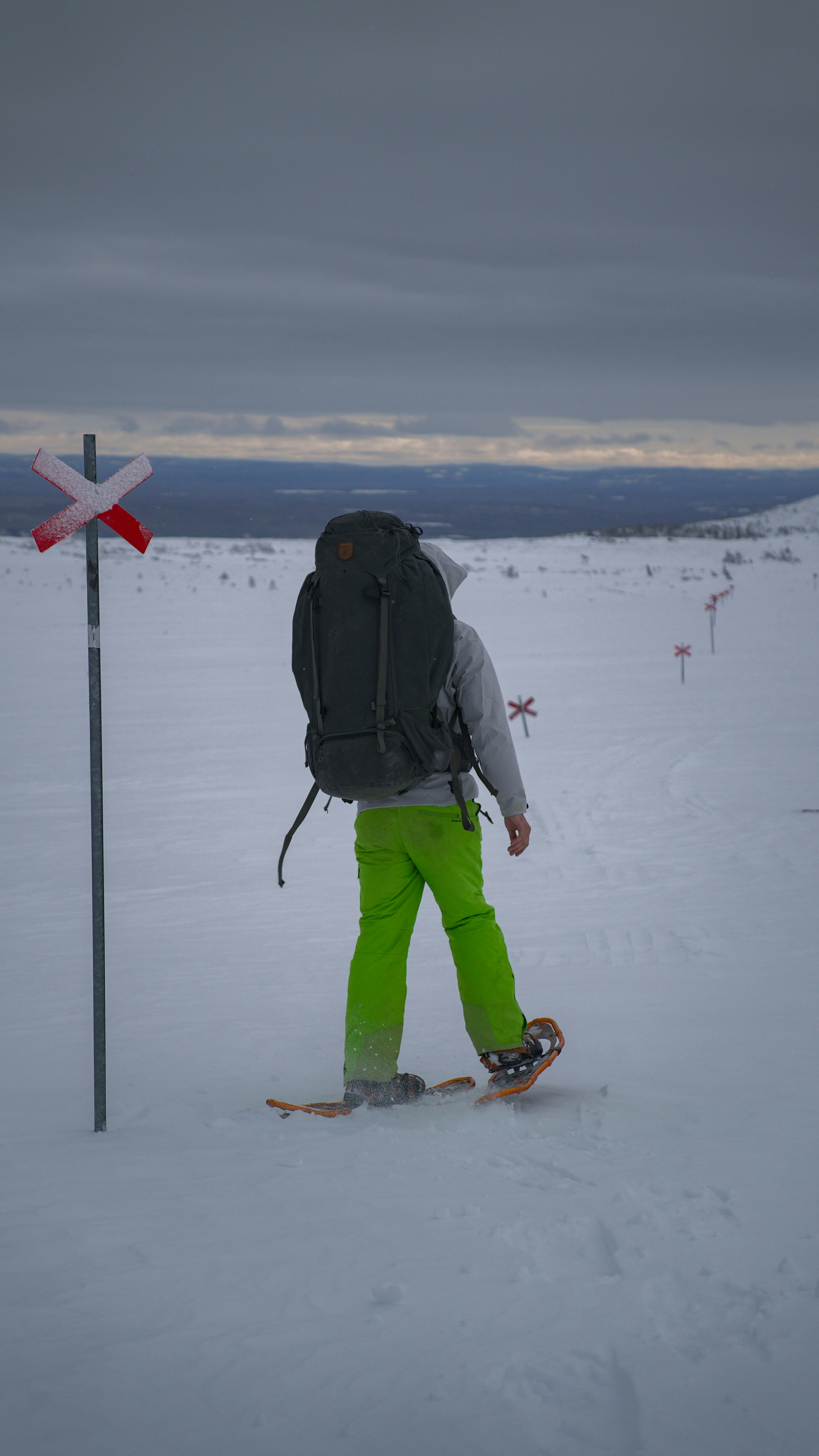 Lime-Panted Snowboarder Crossing a Quiet Frost Field