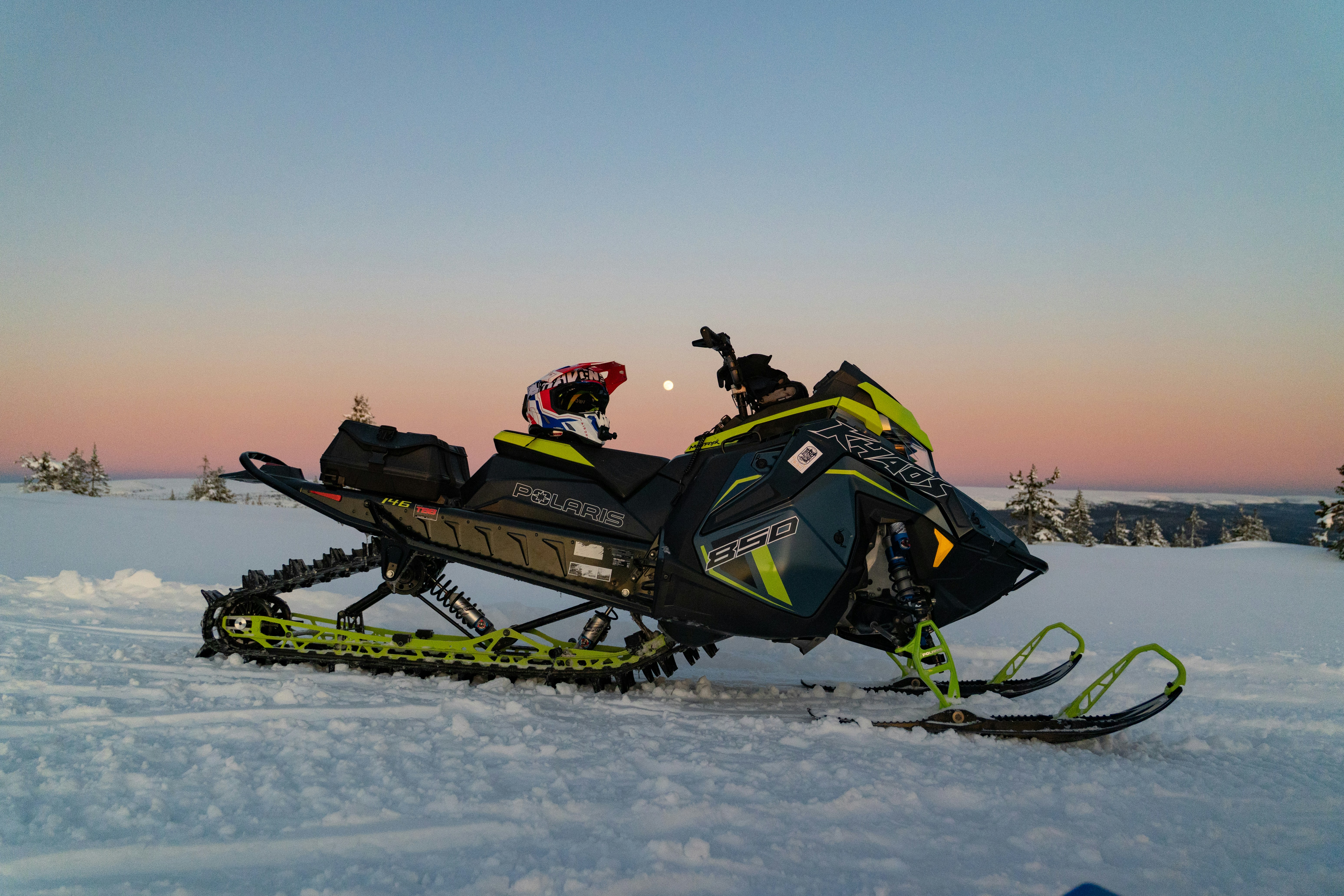 Neon Stride on Silent Snow: Snowmobile at the Dusk Horizon