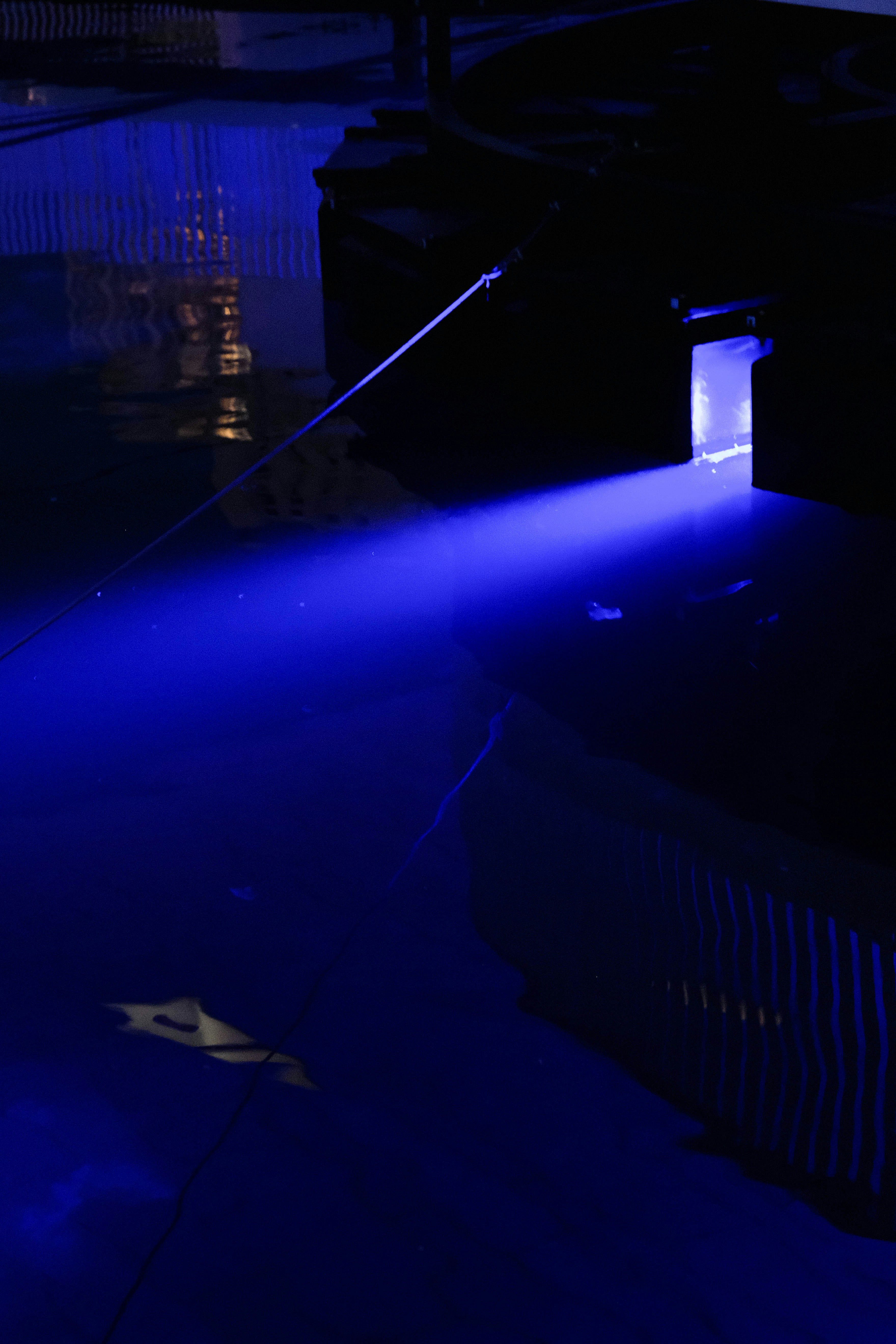 A single beam of blue light illuminates a dark space. photo – Free ...