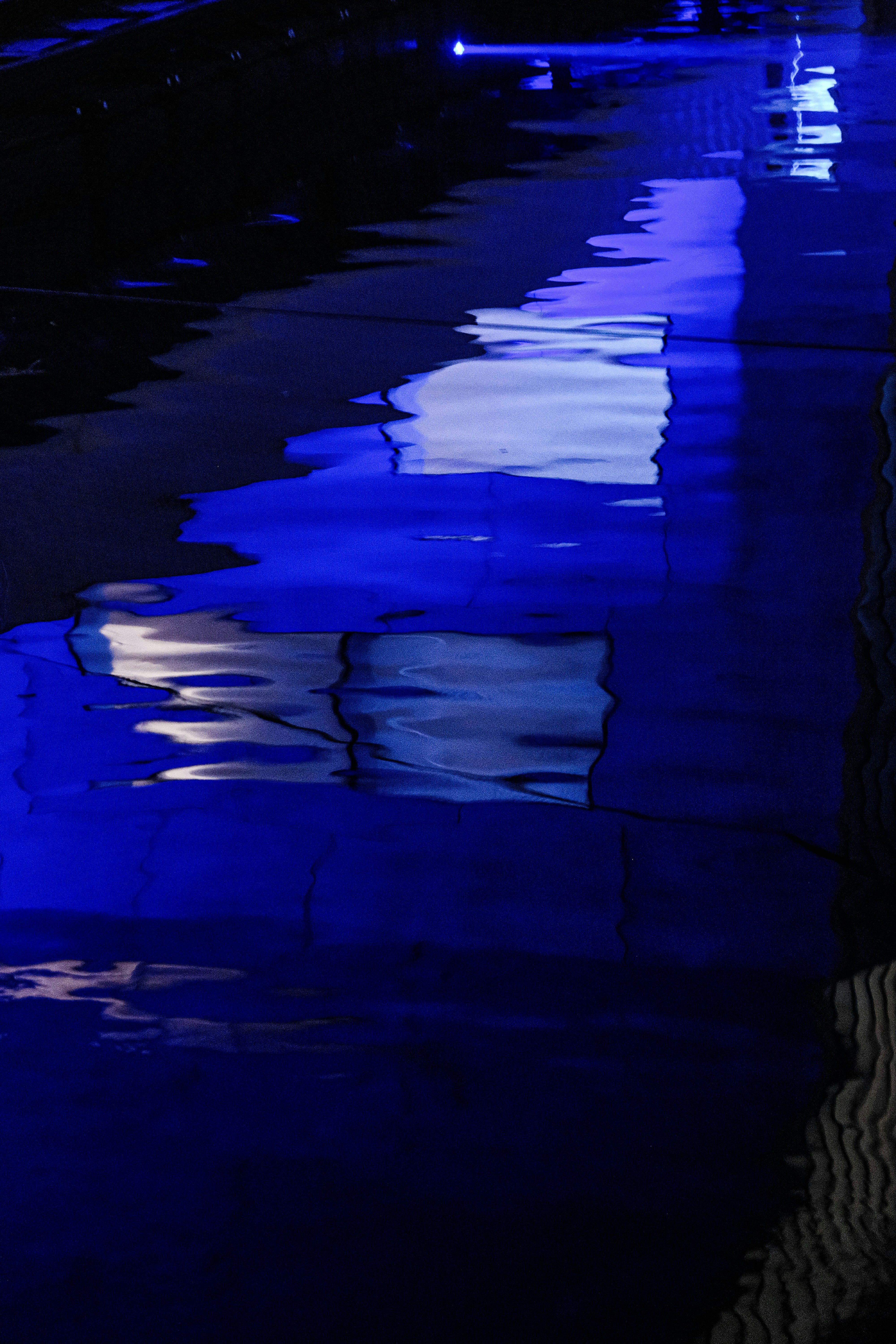 Neon Ripple: Midnight Reflections on a Quiet Pool