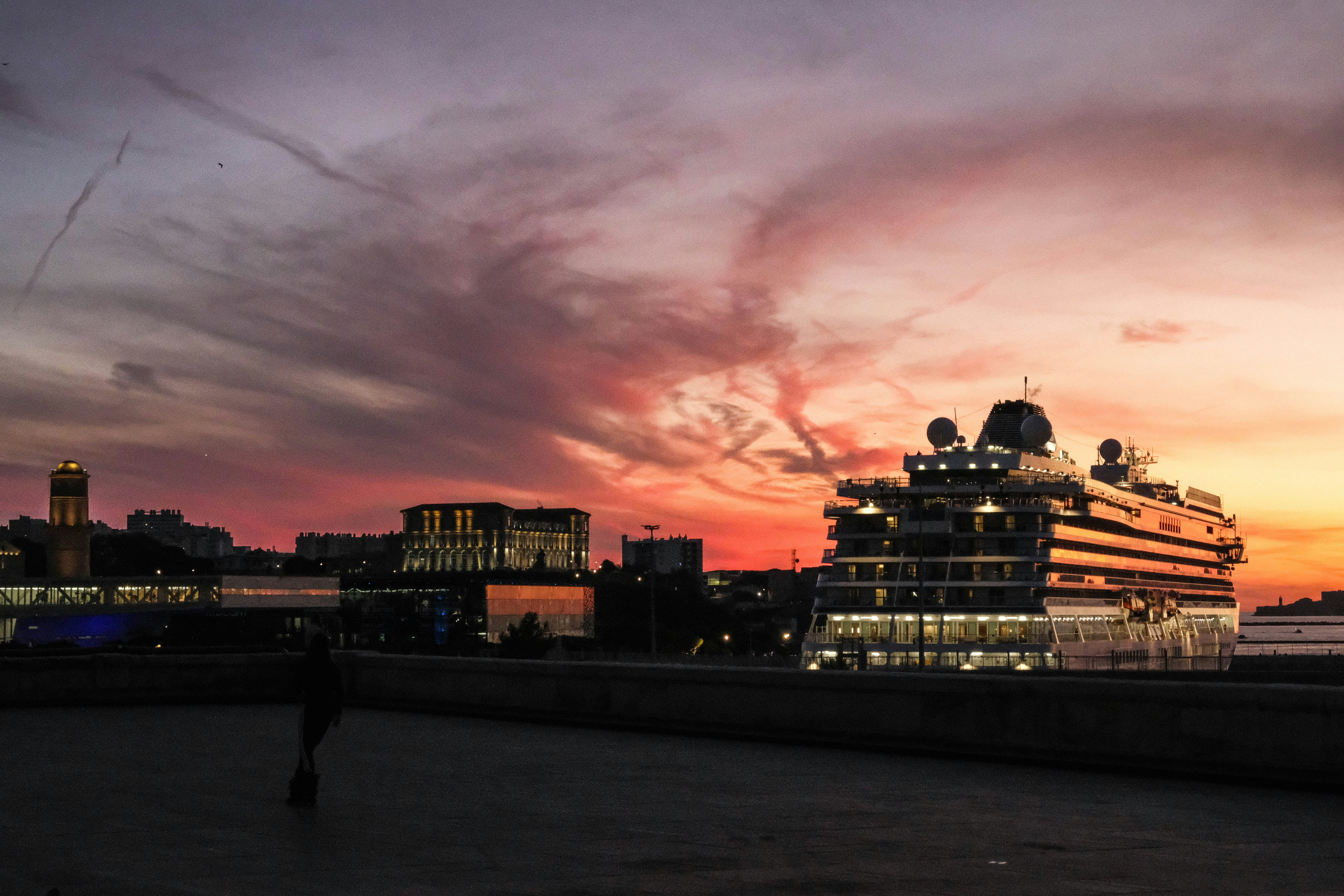 Crimson Harbor at Dusk: The Great Vessel Framed by a Fiery Sky