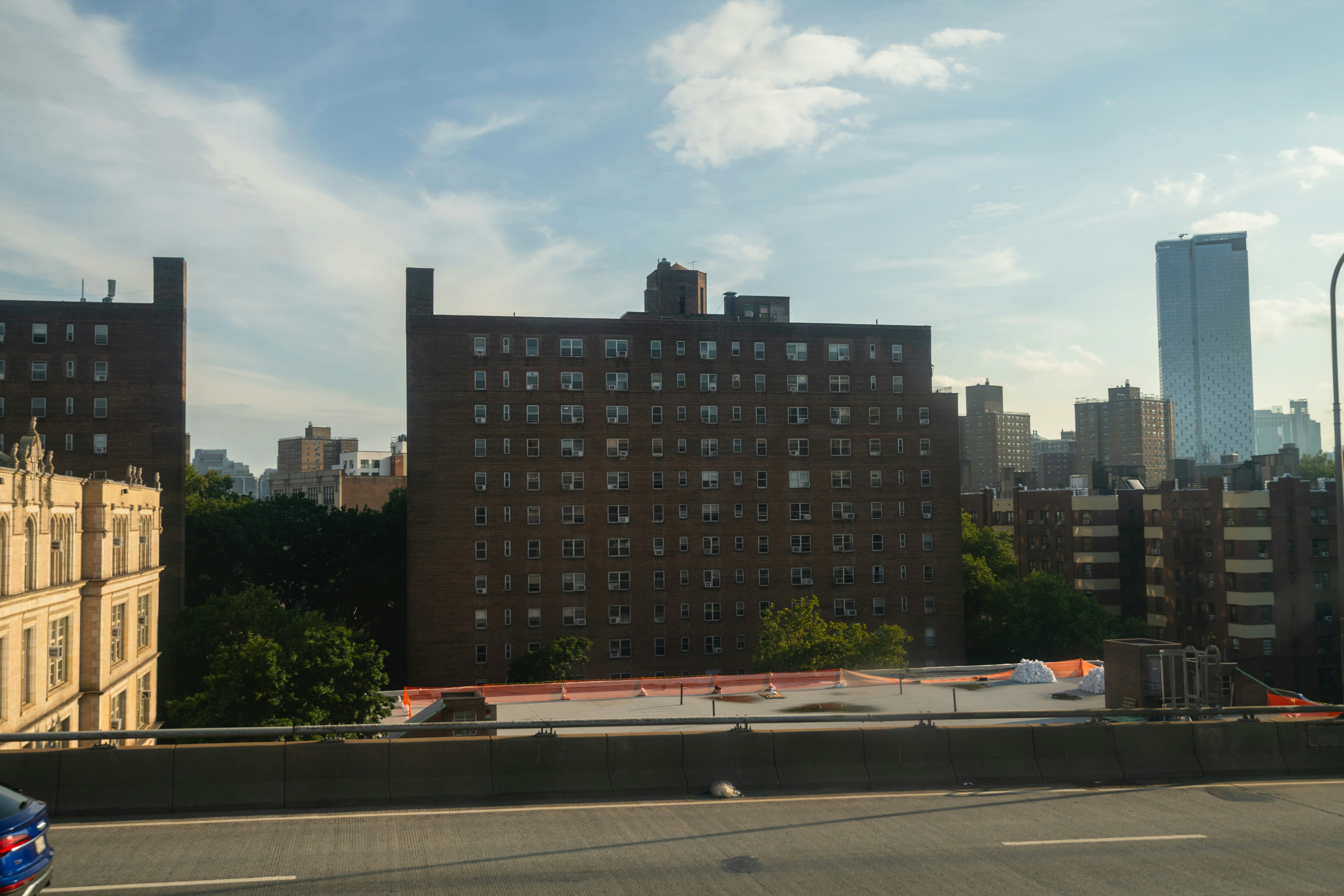 Rooftop Horizon: Brick Facades and the Distant Glass Spire