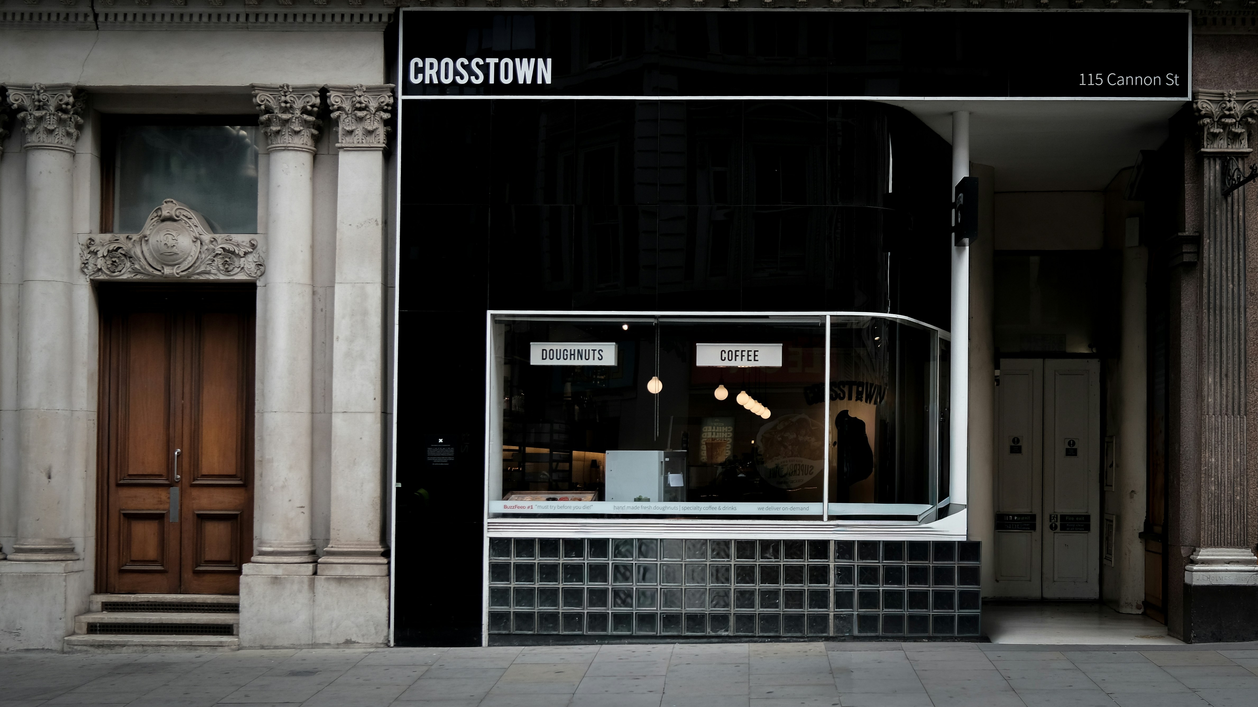 Crosstown Window: A Quiet Urban Portrait on a Black Facade