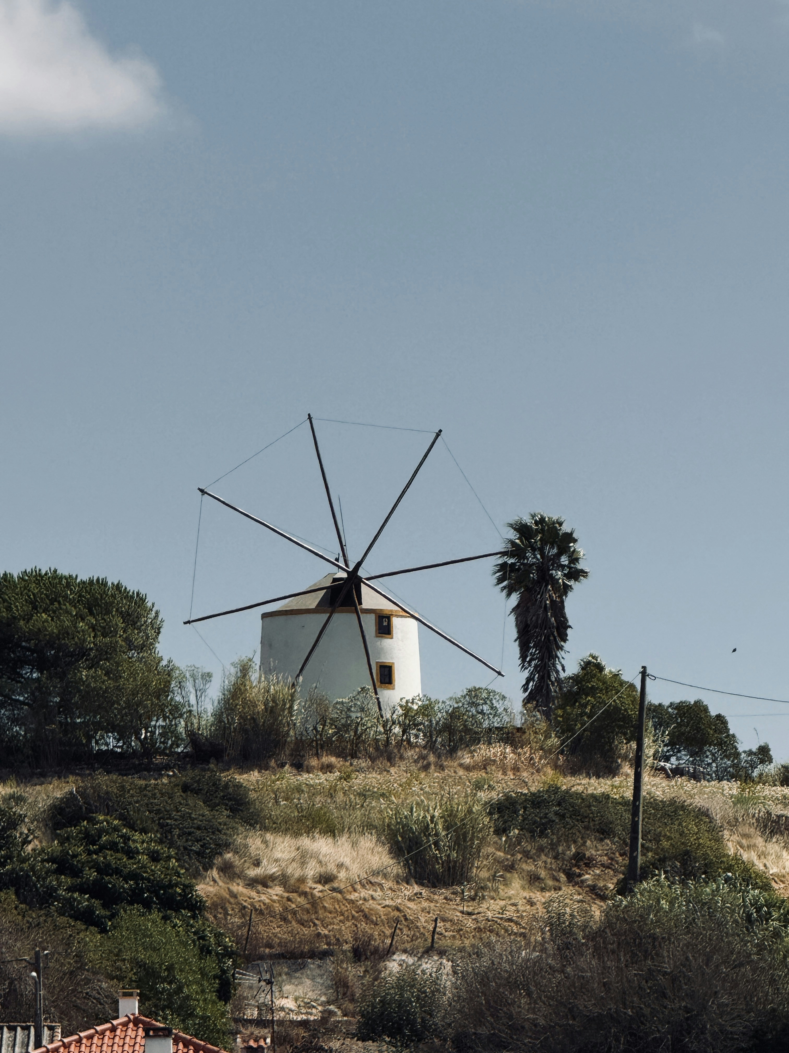 Geometric Windmill on a Sunlit Slope Against a Cobalt Sky