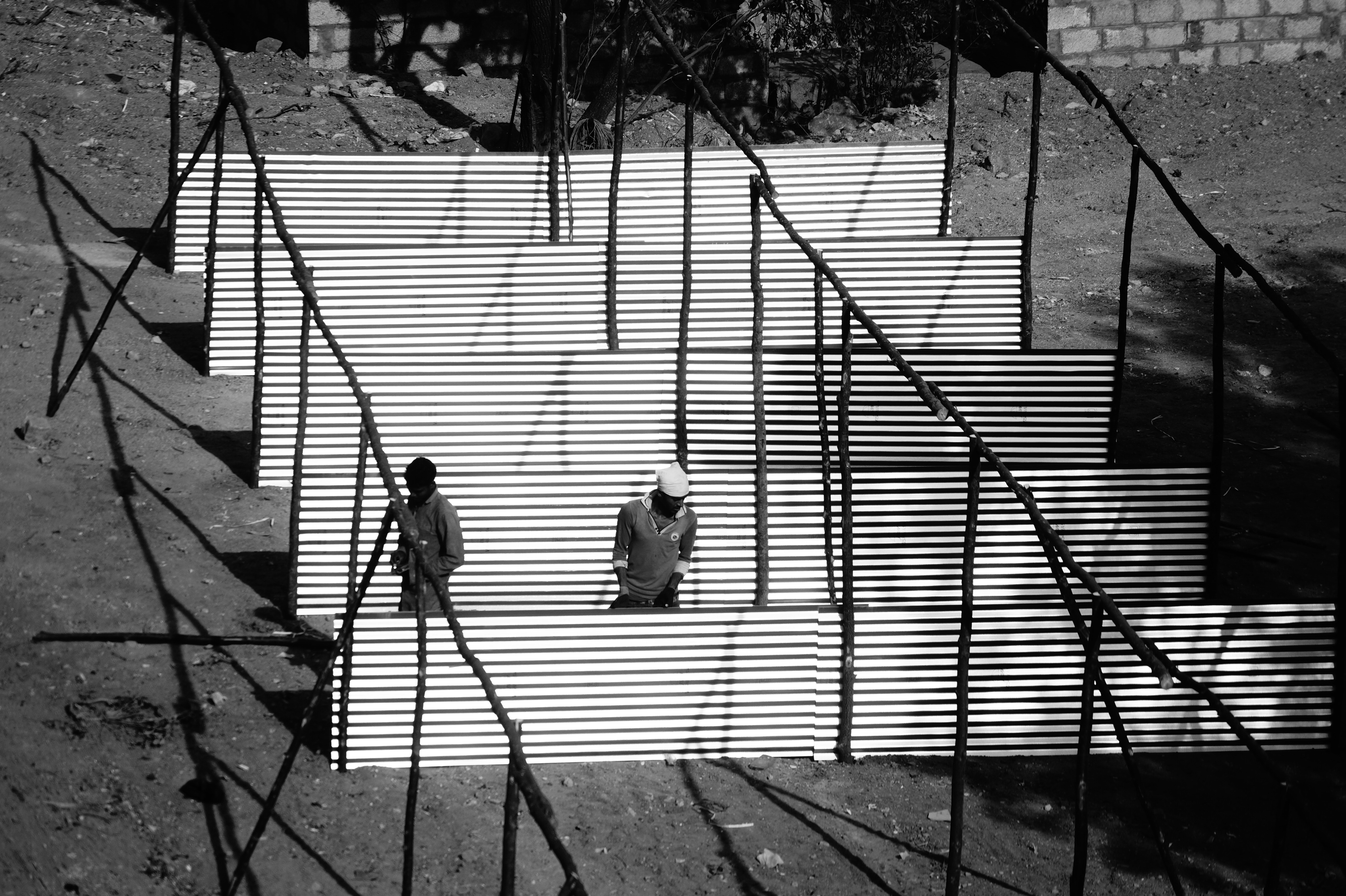 Men working in hot summer building their shelter
