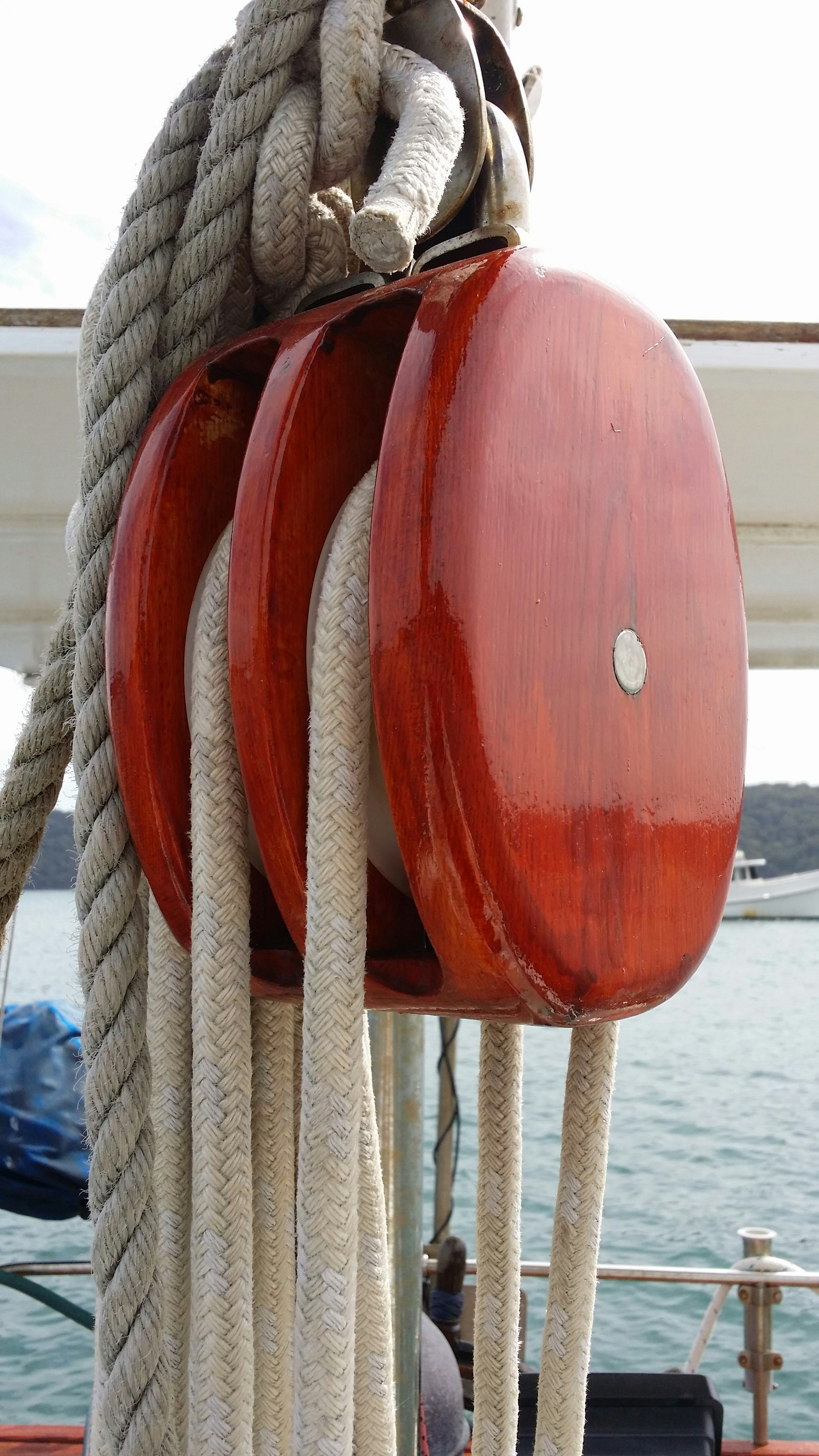Wooden block and tackle with thick ropes on a boat