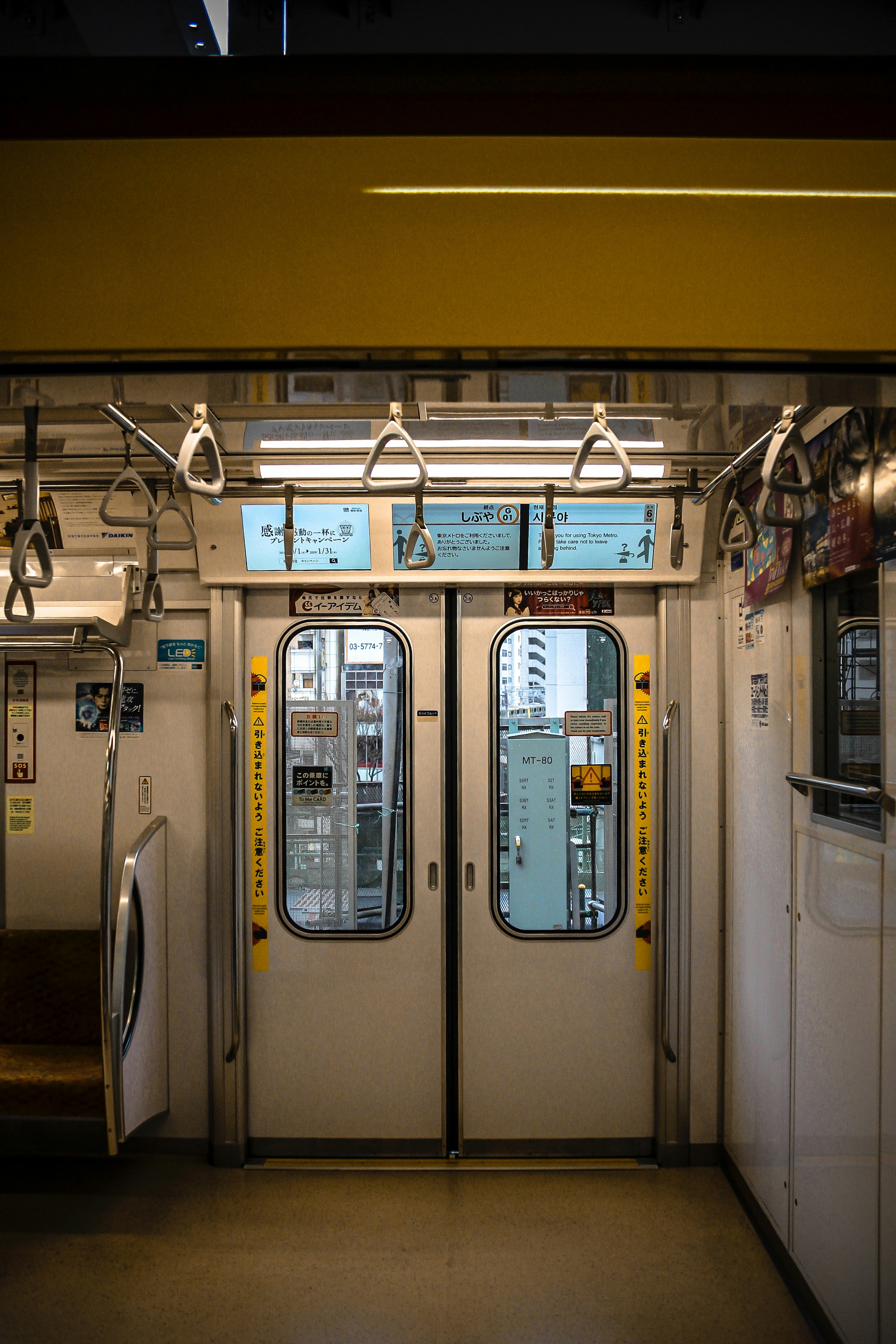 Interior of a train car with closed doors.