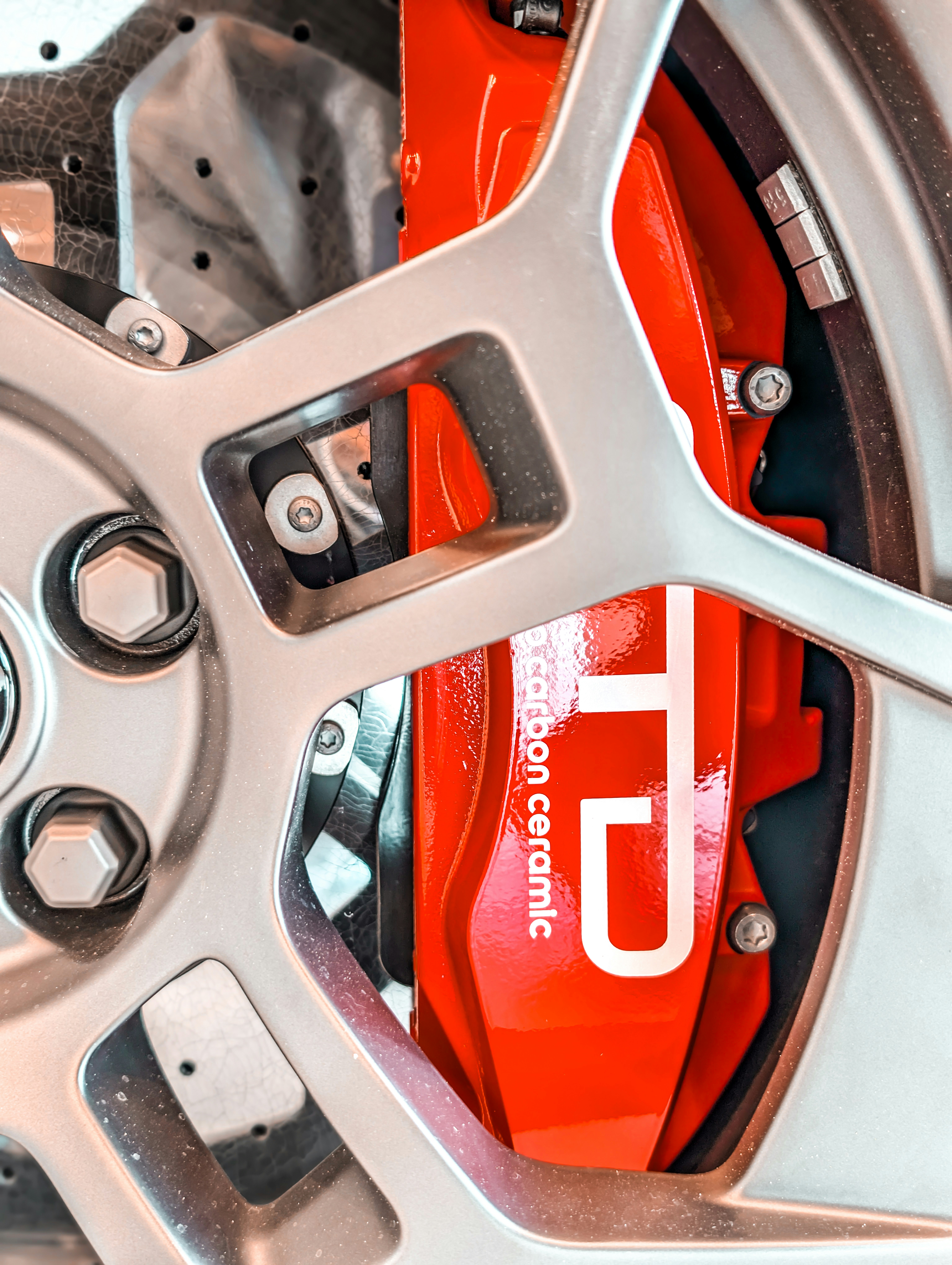 This close-up is just stunning! The vibrant red "GTD" carbon ceramic brake caliper pops brilliantly against the intricate, high-performance wheel, showcasing the incredible engineering detail of a true supercar. Boulevard Ford in Millsboro