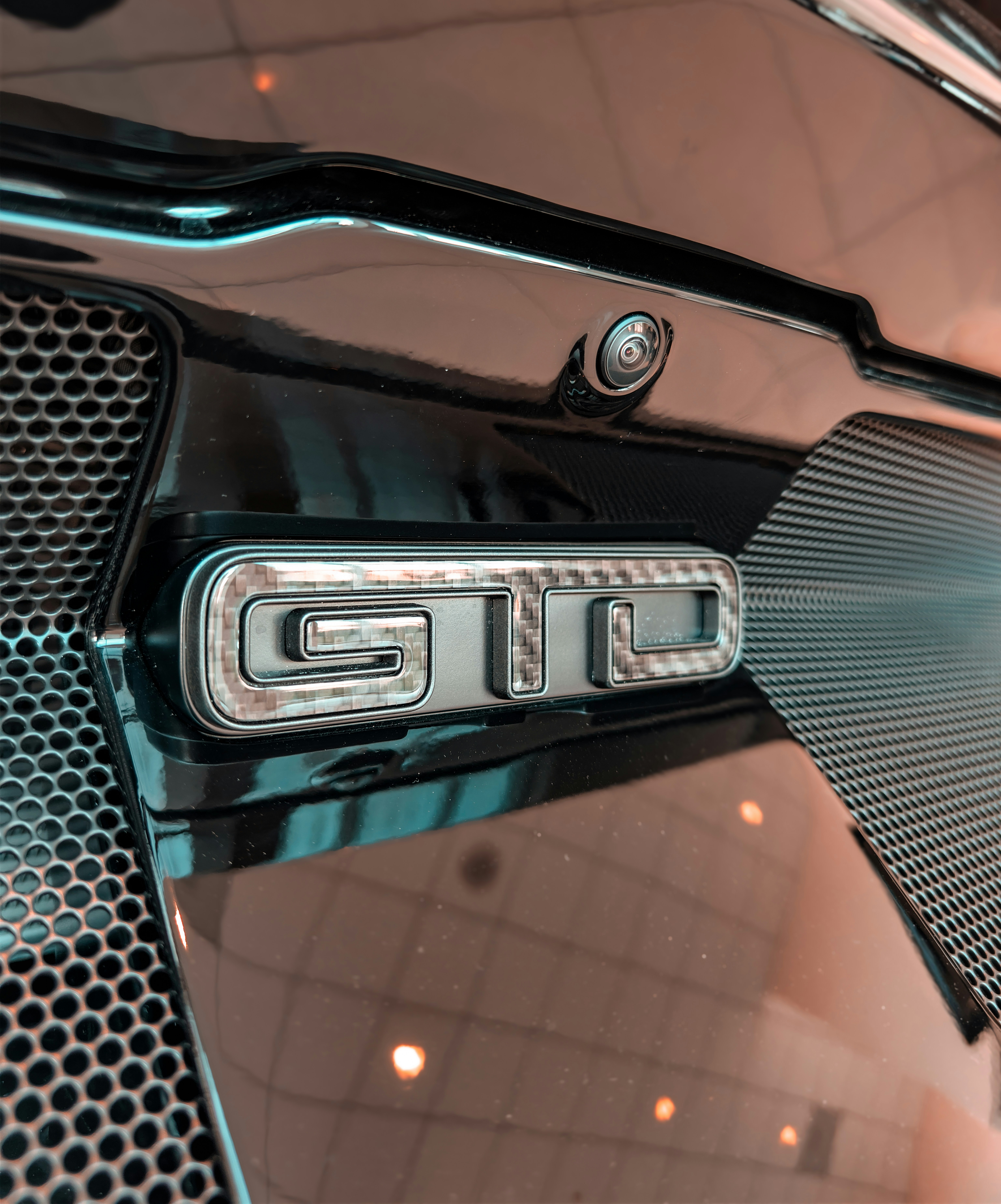This moody shot is just gorgeous. The "GTD" emblem, with its intricate carbon fiber detail, looks so powerful and sophisticated set against that flawless, reflective black finish.