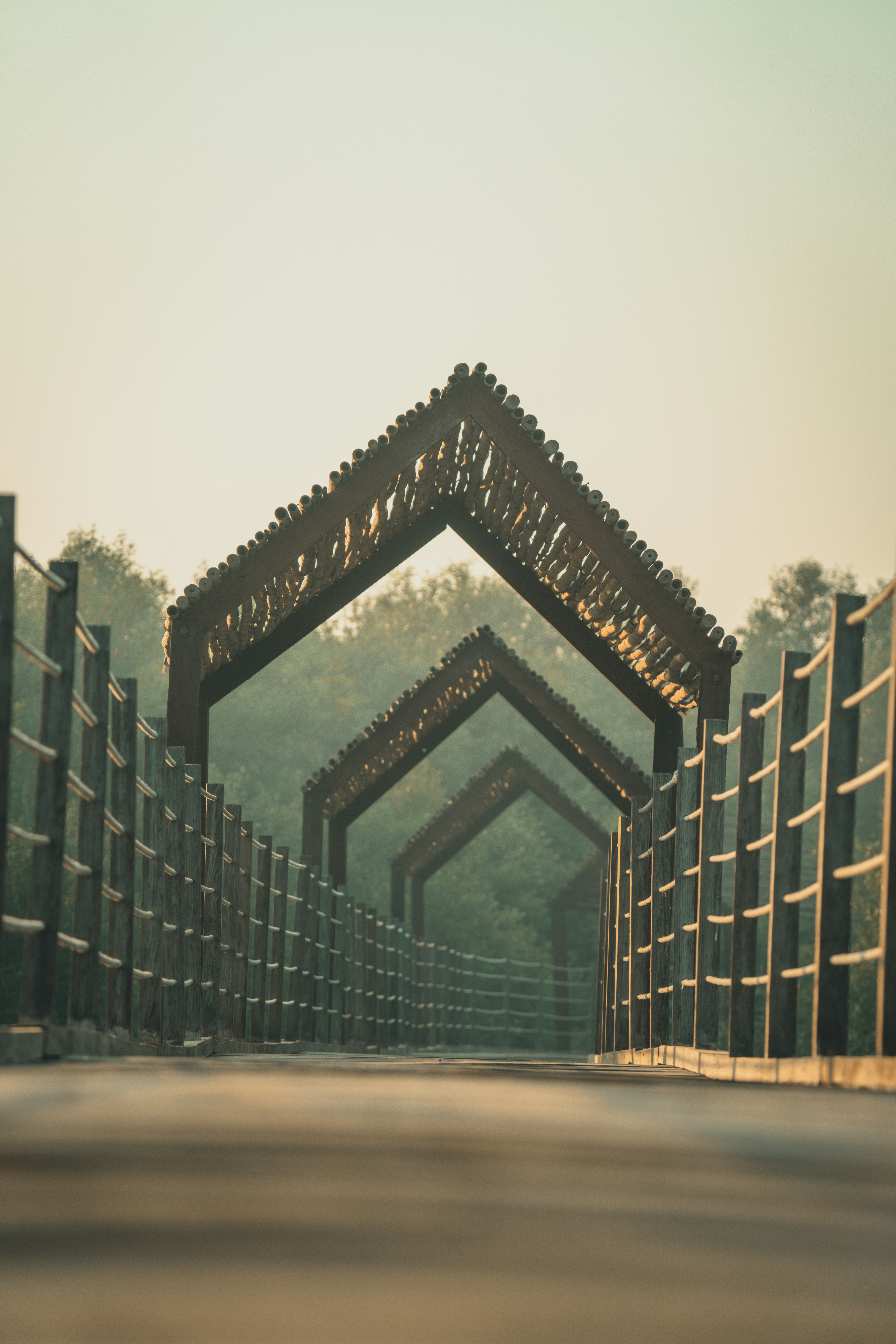 Dusk-lit Archway Corridor: Receding Frames on a Quiet Pedestrian Bridge