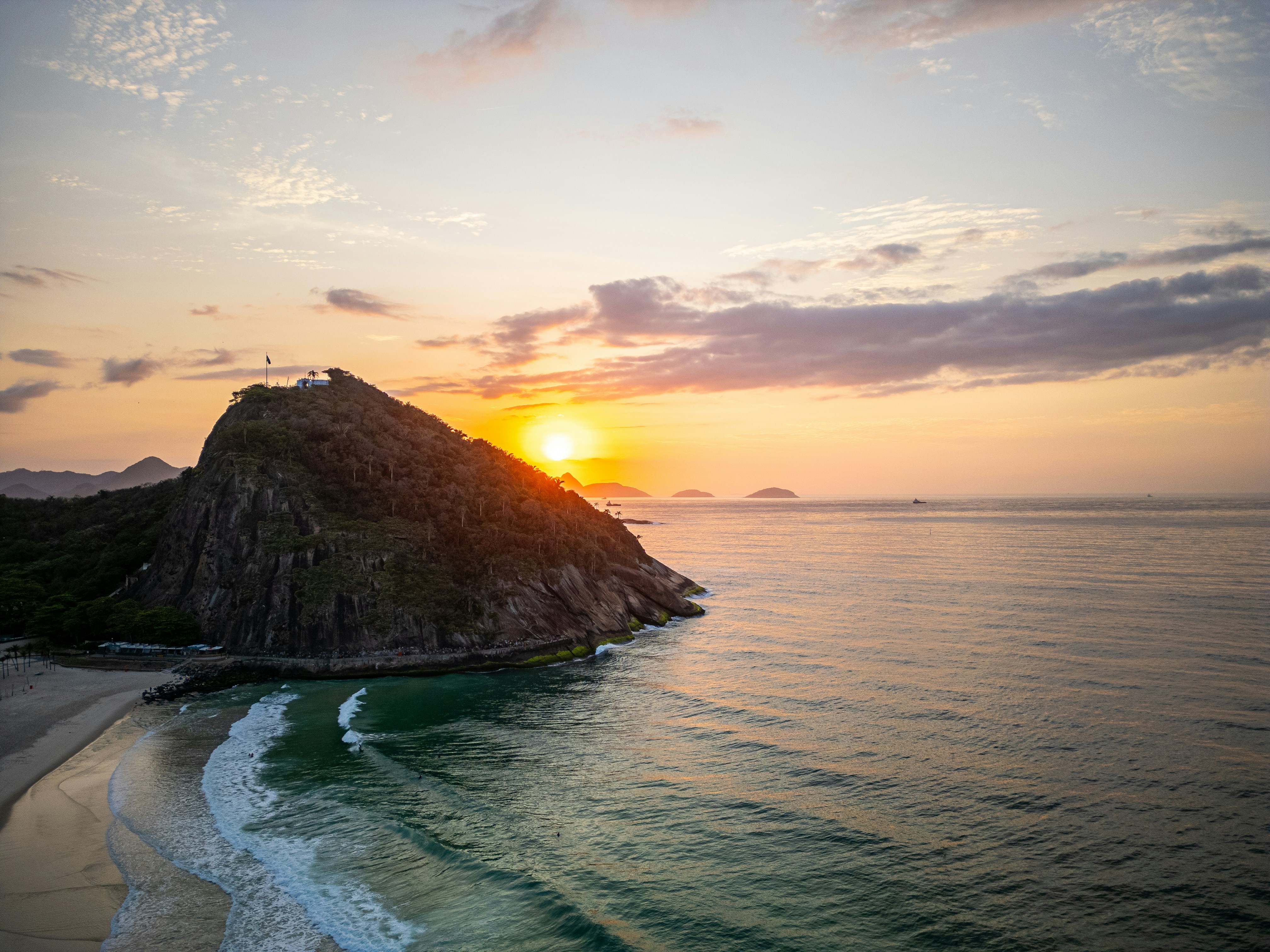 Dusk Over the Rocky Headland: Sunlit Calm Along a Quiet Cove