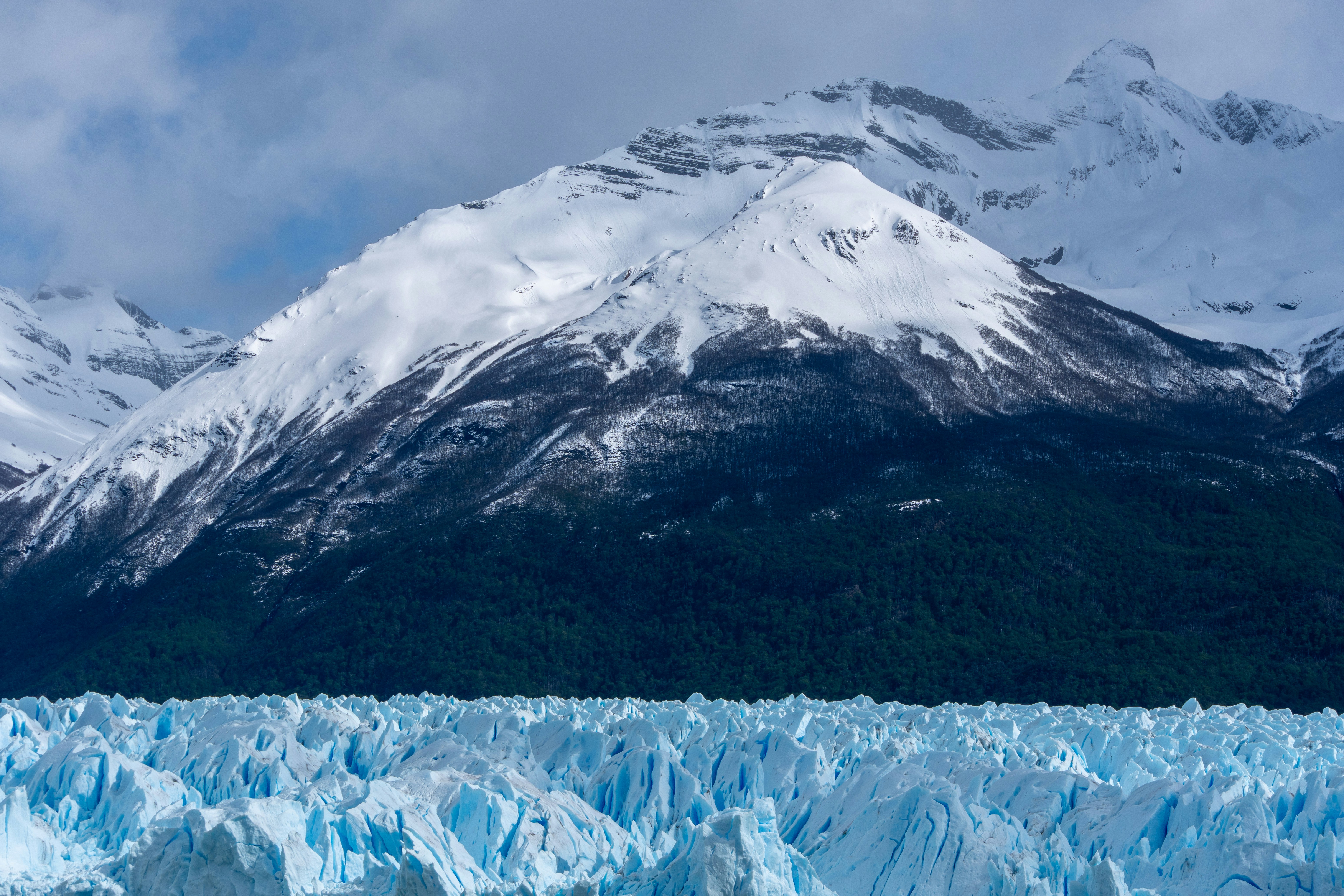 Blue Crevasses at Dawn: Glacier Teeth Against Alpine Snow