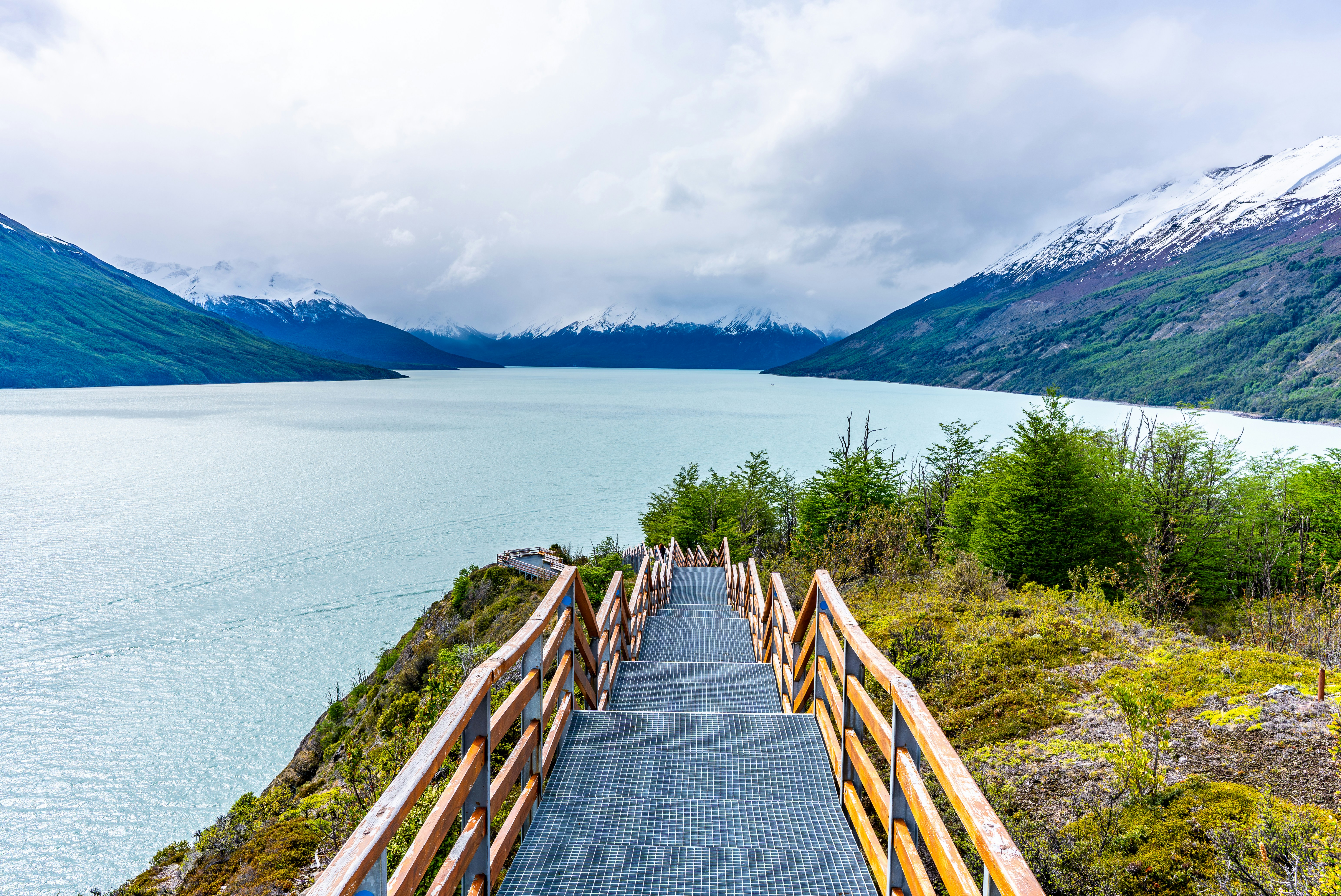 Bridge to the Blue Fjord: A Narrow Metal Path Framing a Mountain Lake