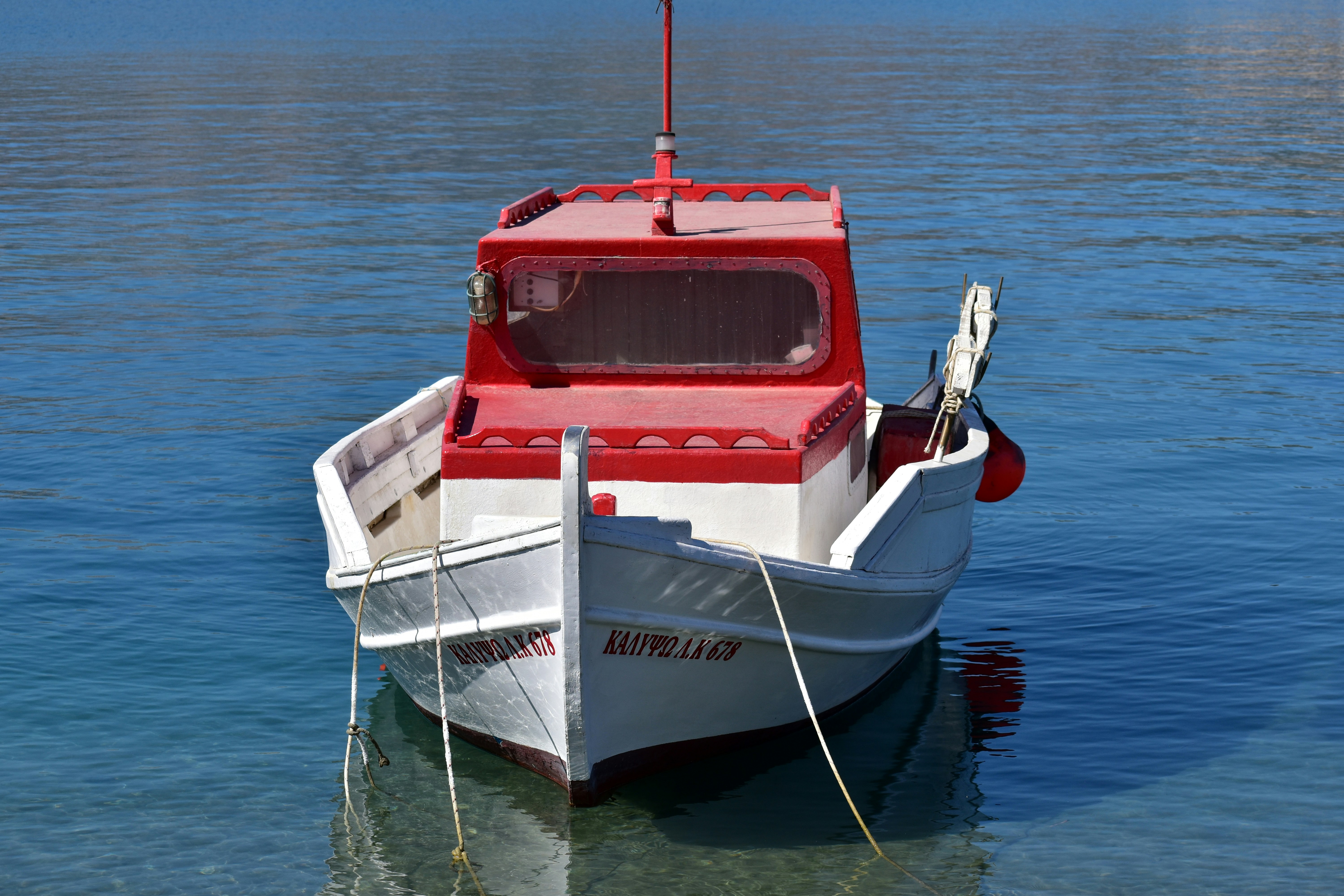 Red-Capped Cabin Boat Anchored in Cerulean Quiet