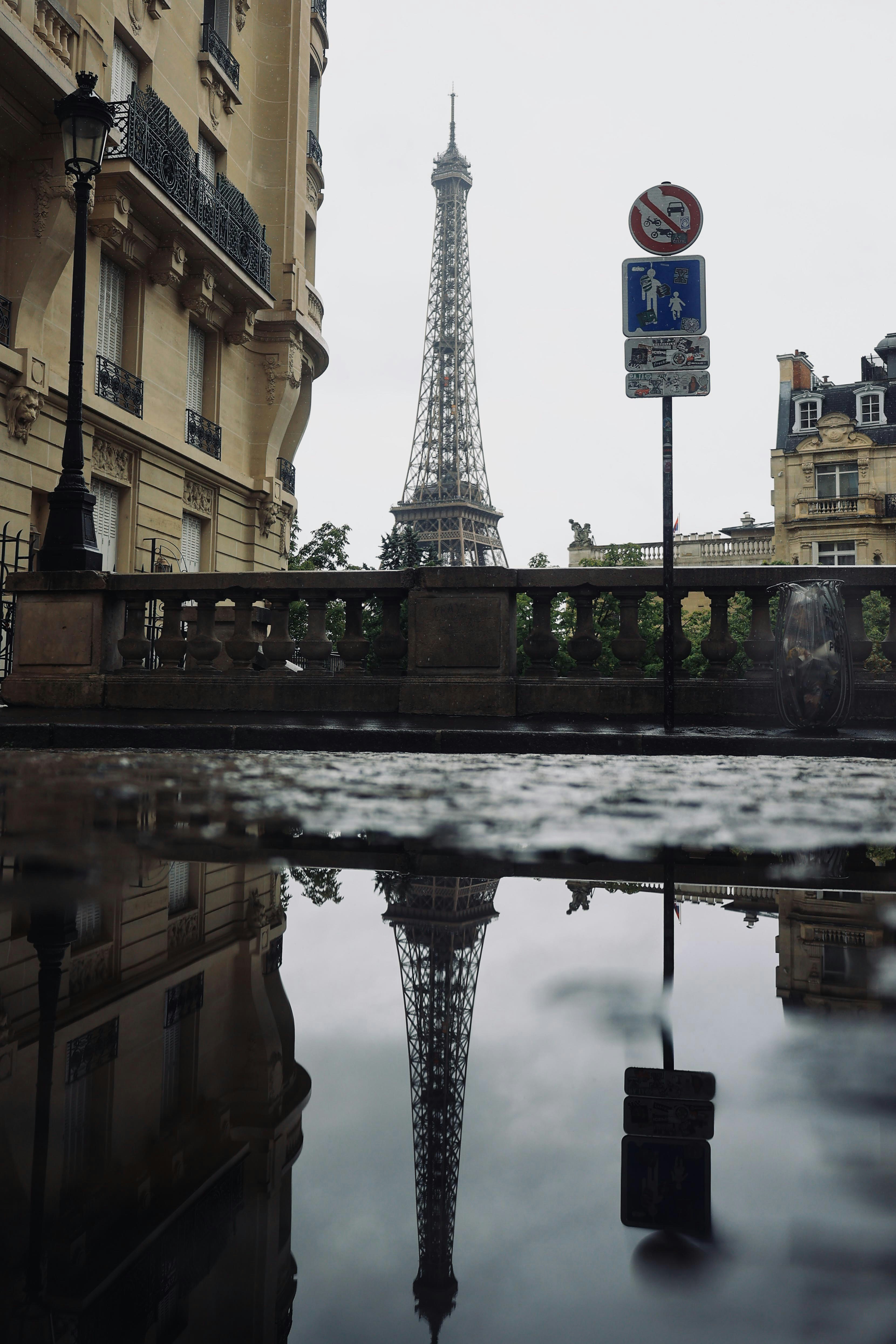 Iron Lace at Street Level: Eiffel Tower in a Wet Parisian Mirror