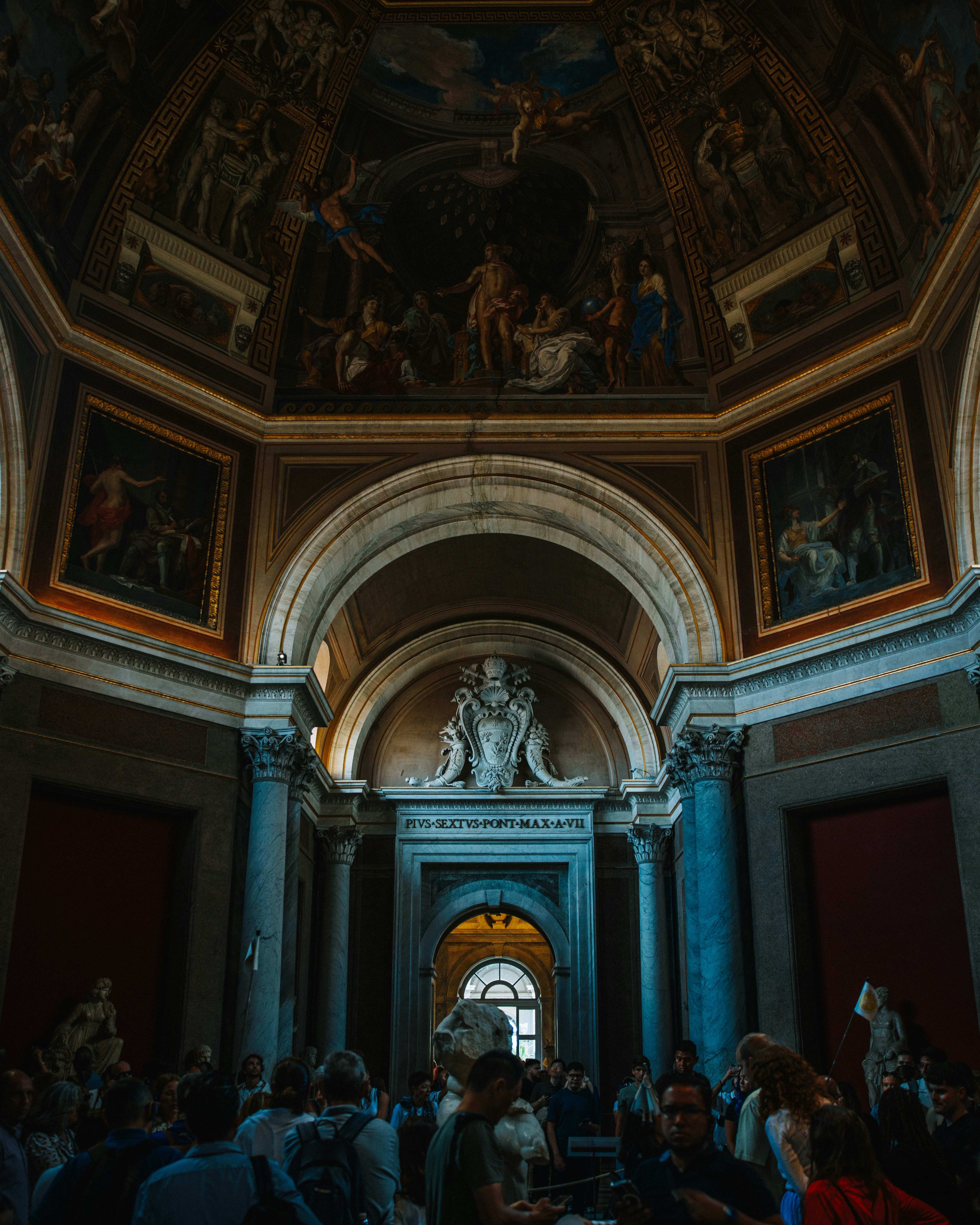 Archway Illumination: Crowds Beneath a Baroque Dome