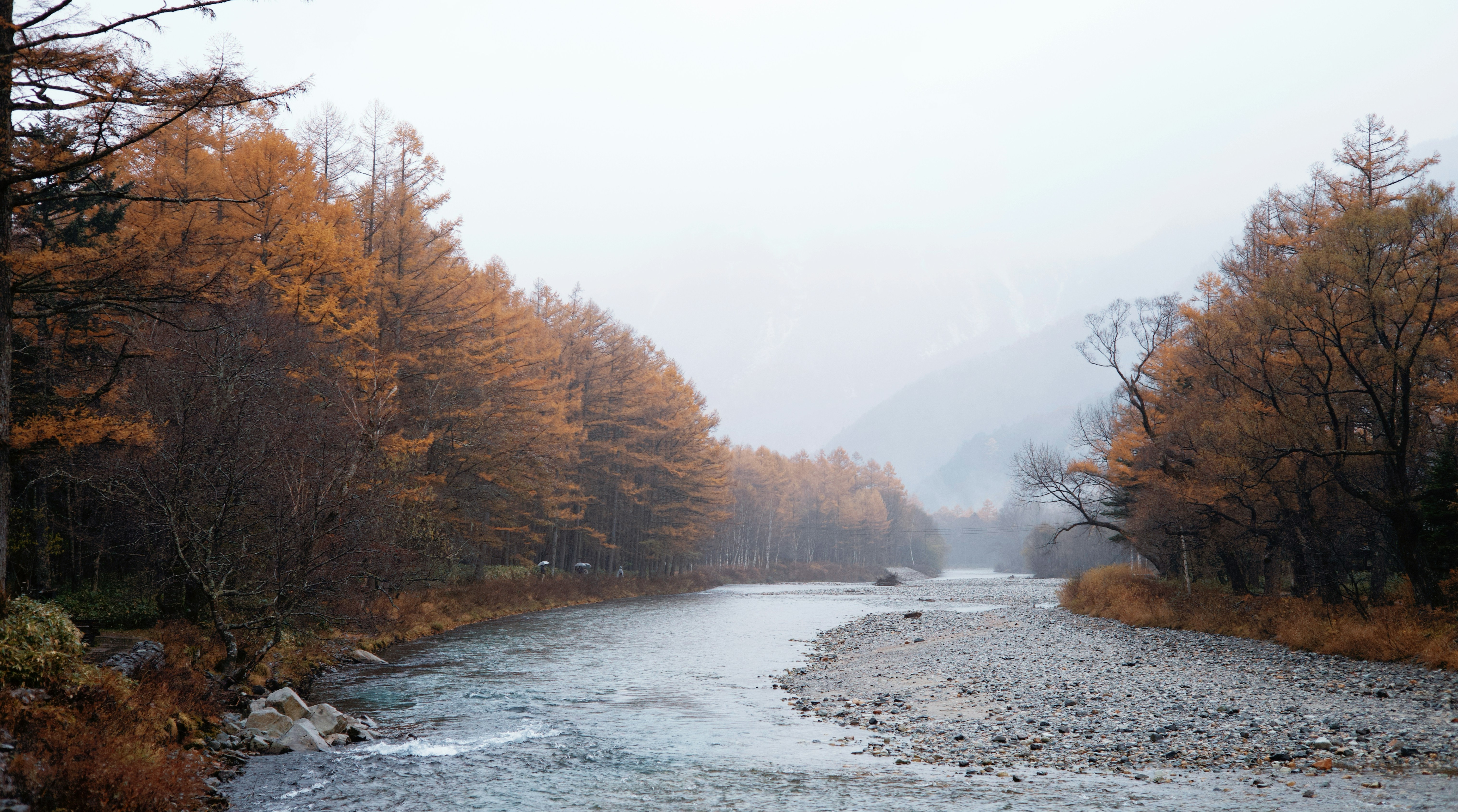 Autumn River Bend beneath Misty Peaks
