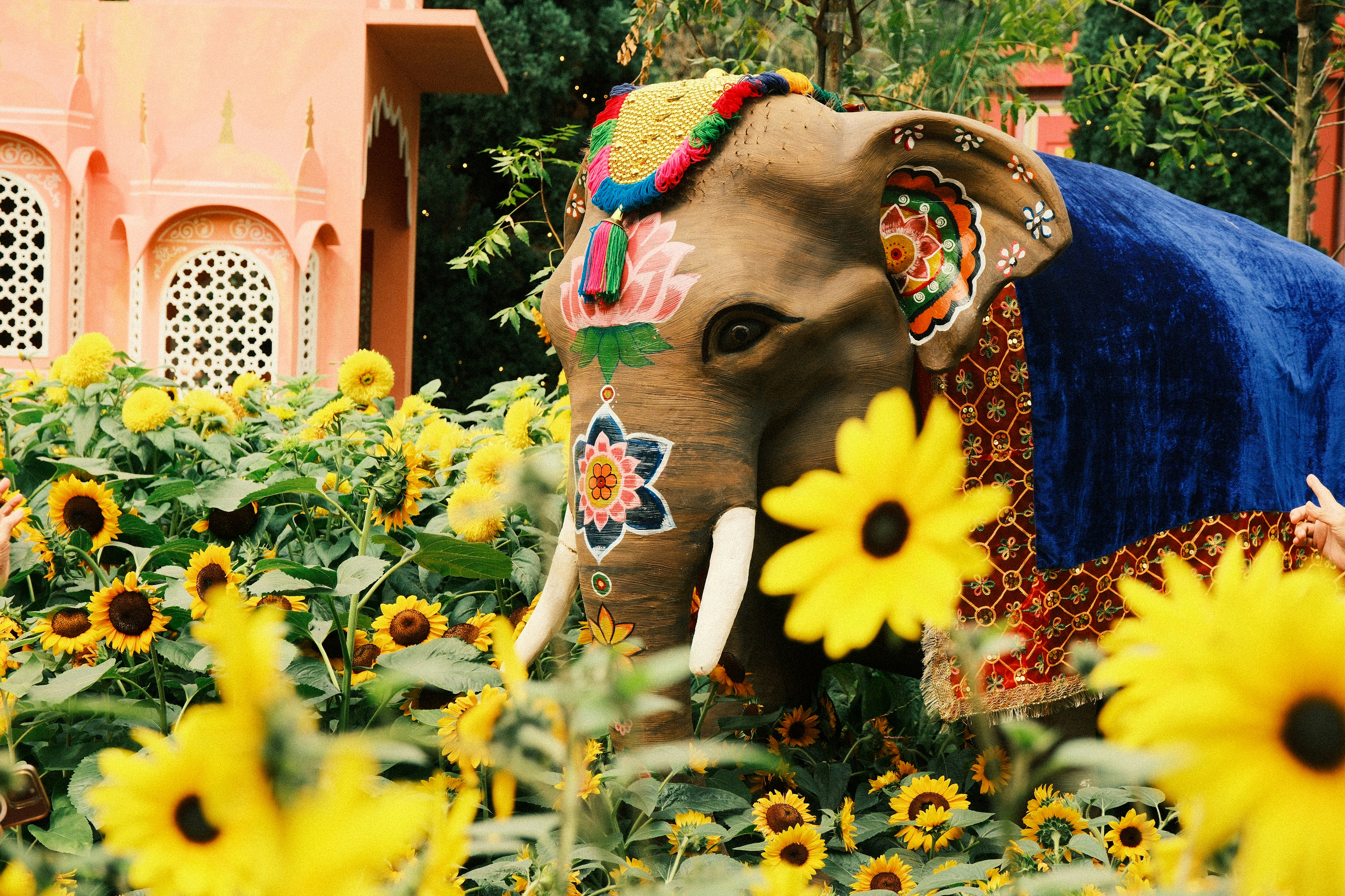 Sunflower Parade: A Decorated Elephant in a Radiant Courtyard