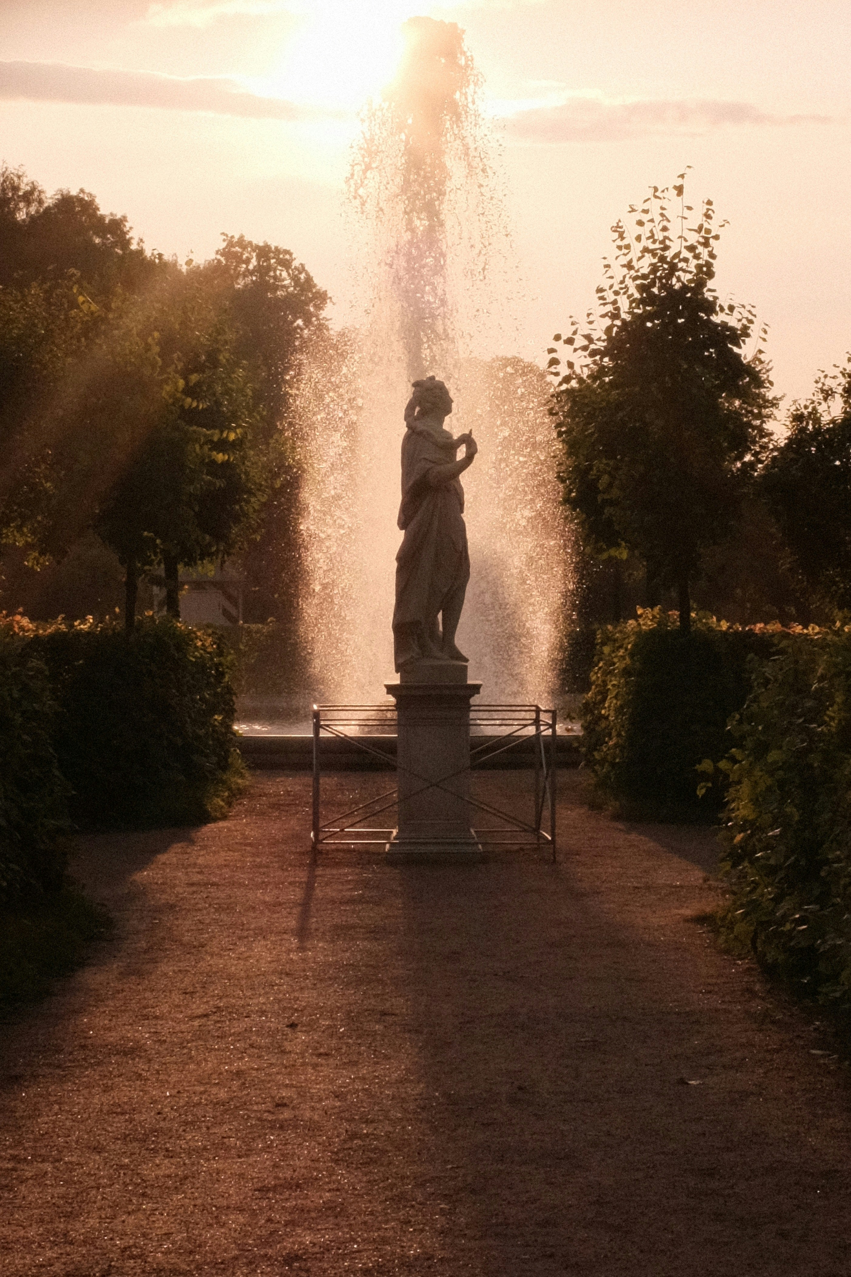 Sunlit Statue at Dusk: A Fountain in Silence
