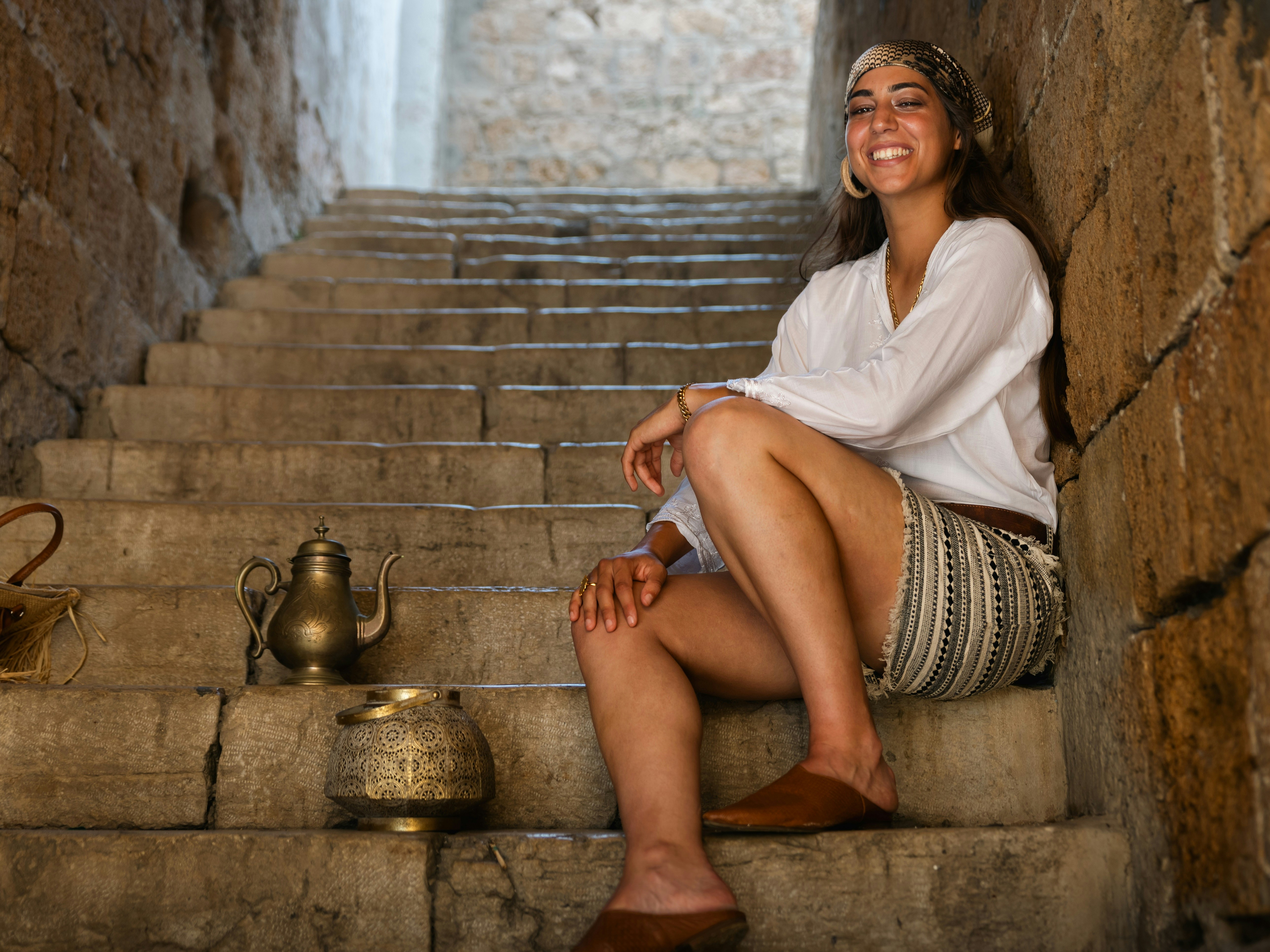 Warm Light on Carved Stone Steps: A Quiet Portrait in an Ancient Corridor