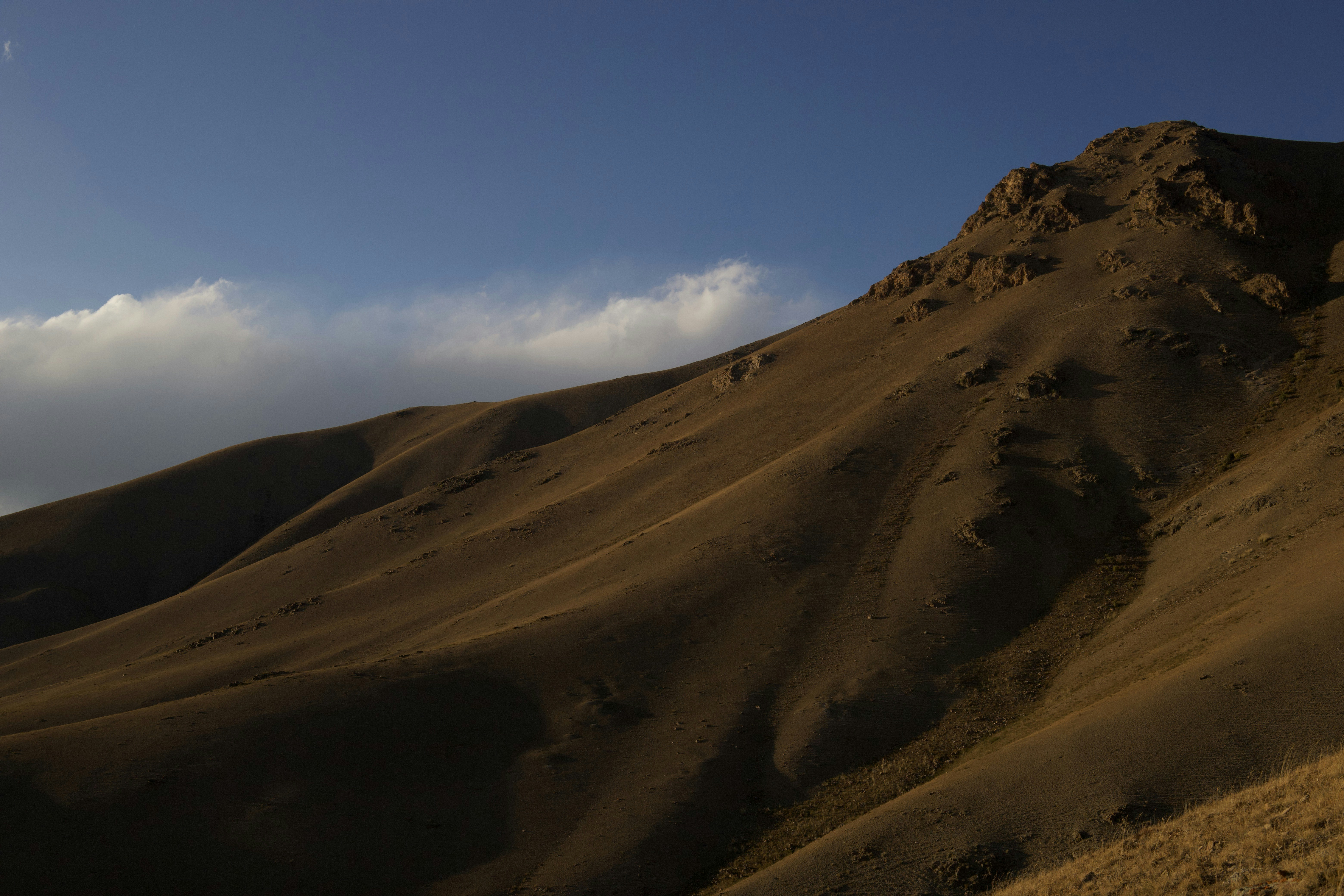A smooth rolling mountainside in Kyrgyzstan, en route to the Son Kul lake.