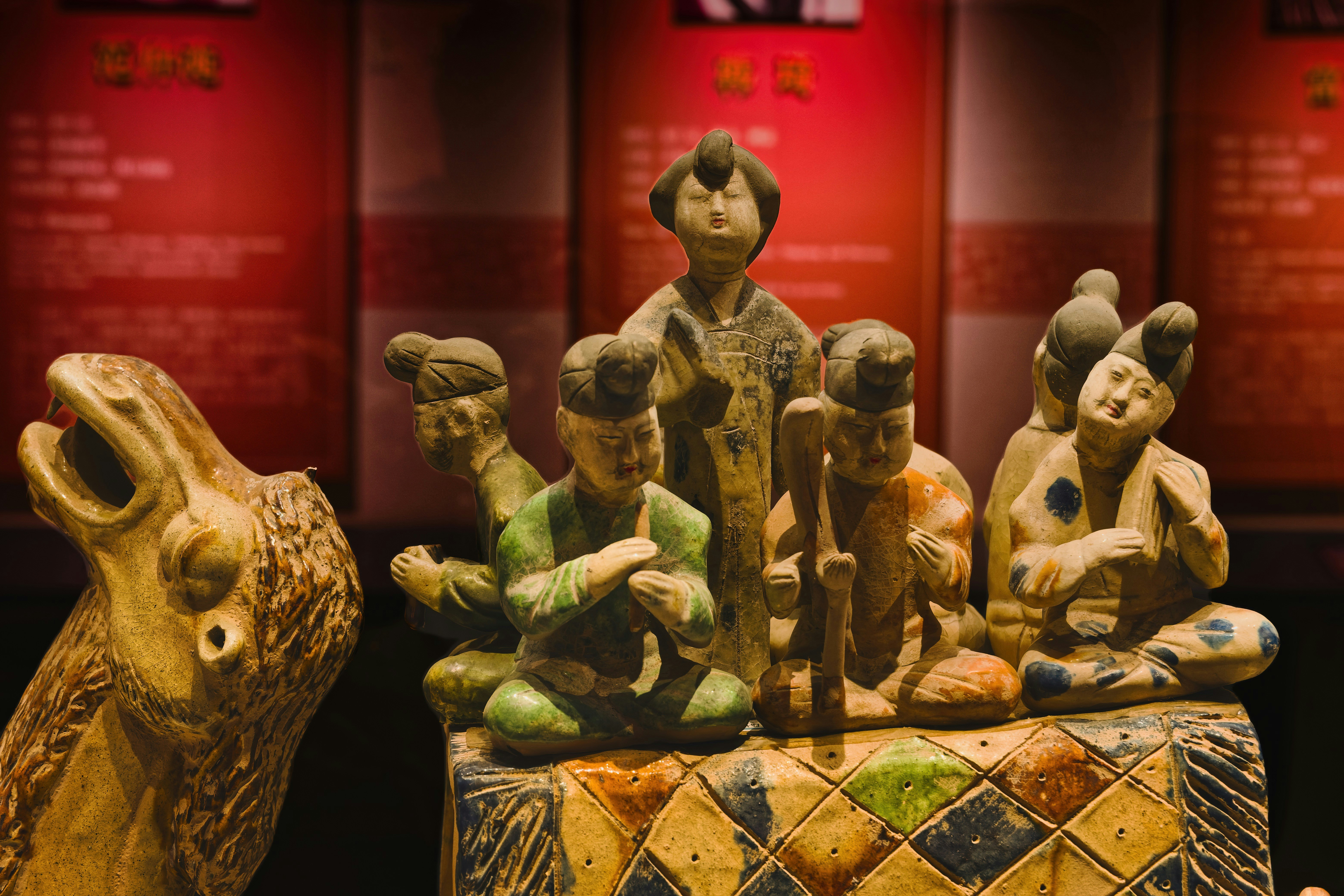 Whispering Figures in a Velvet Red Gallery