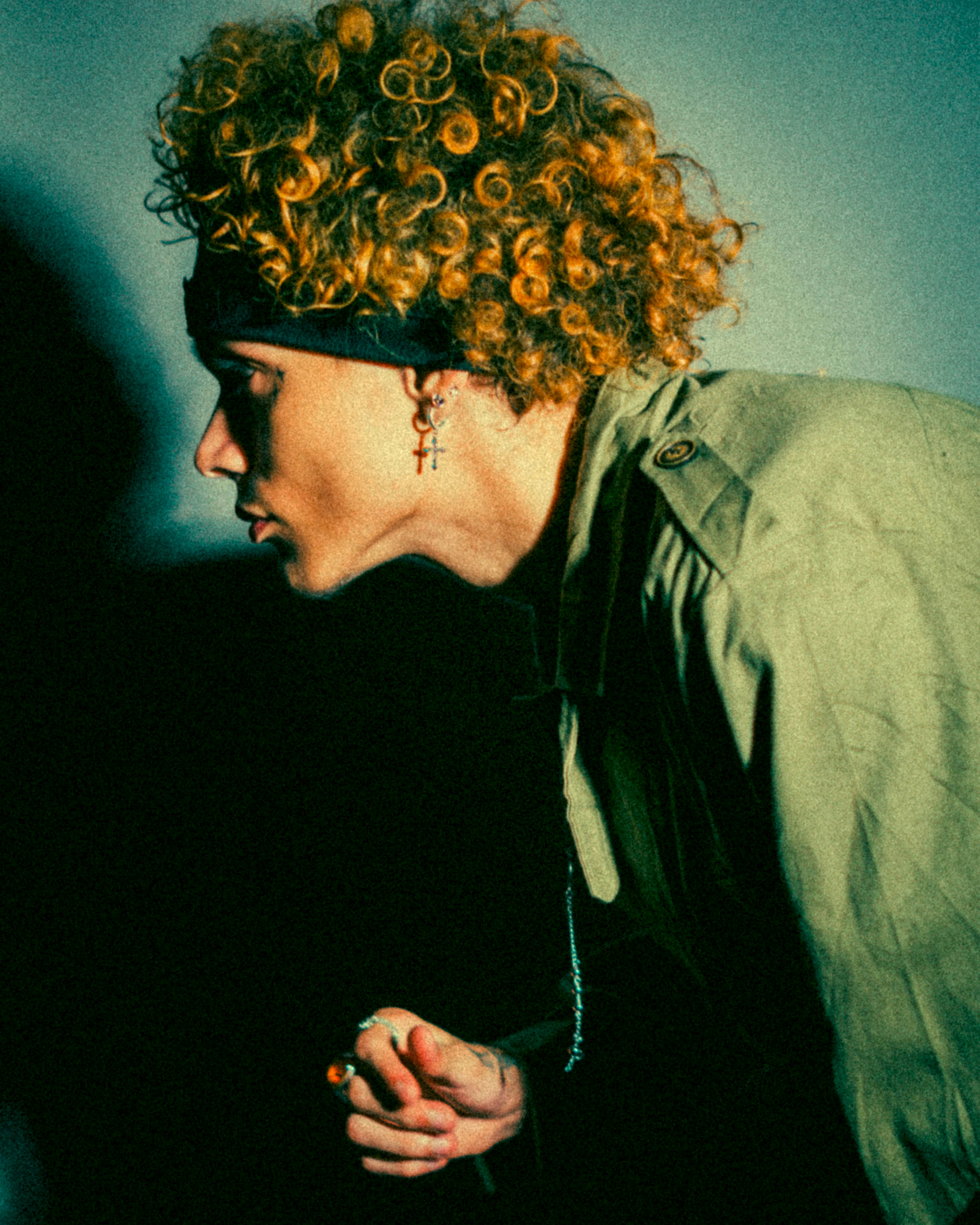 Neon Shadow Profile: Curly-Haired Figure in Olive Gear